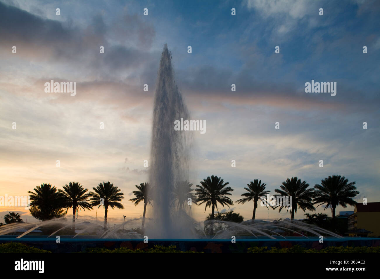 Bahamas Grand Bahama Island Freeport Setting sun silhouettes fountains ...