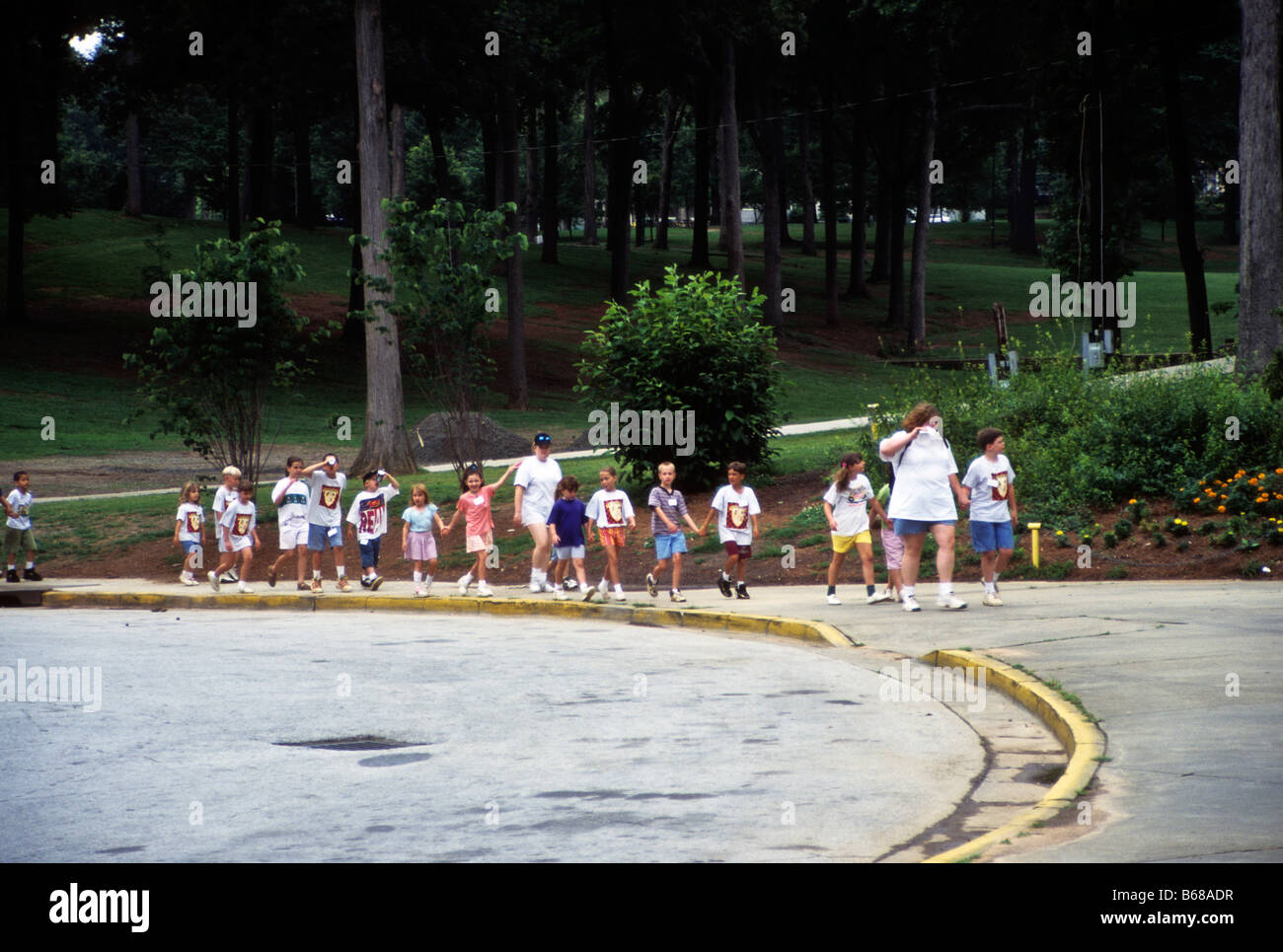 Group of school children walk in group through park in Washington, DC ...
