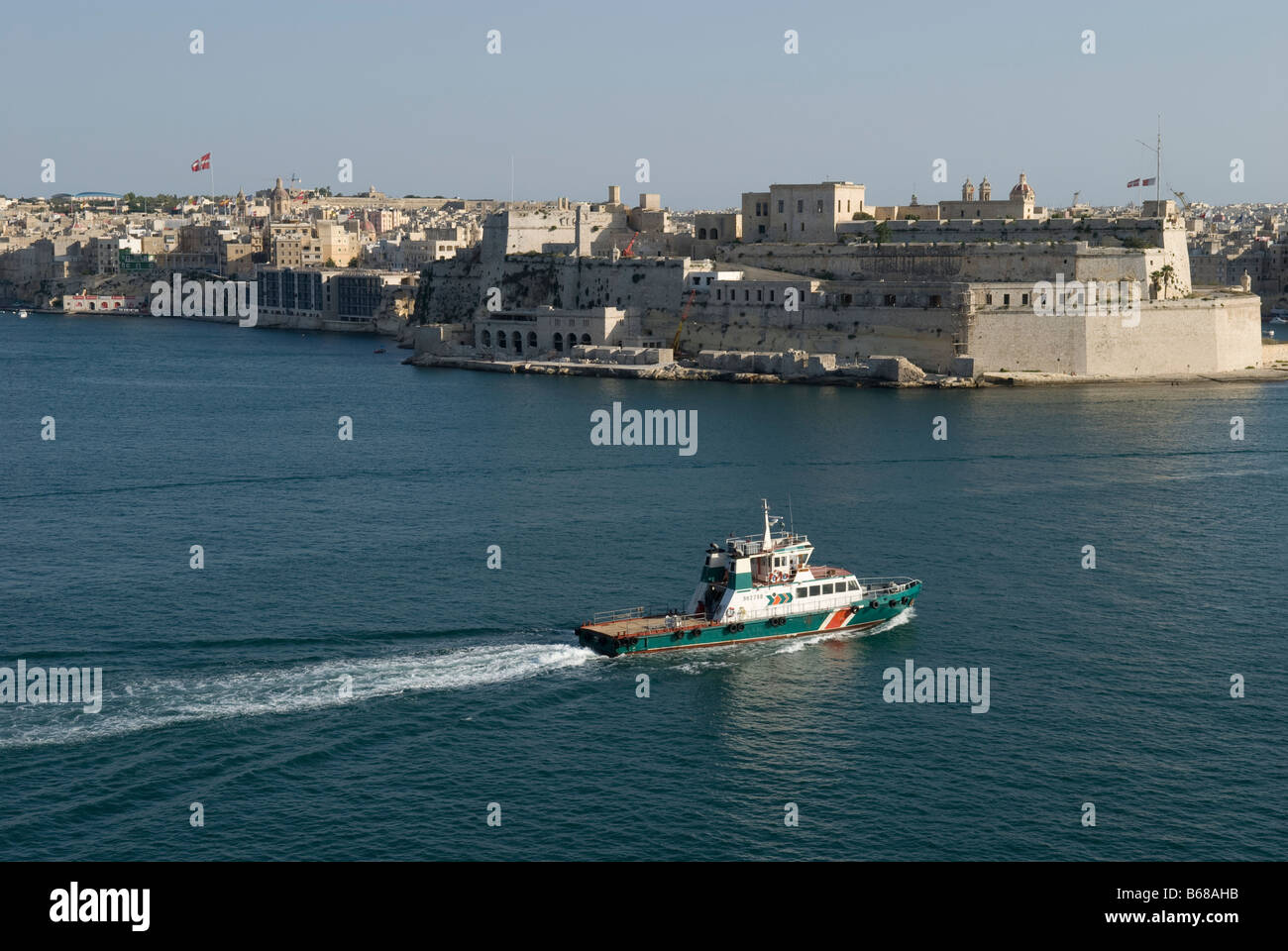 Boat in Grand Harbour with Fort St. Angelo, from Lower Barrakka Gardens ...