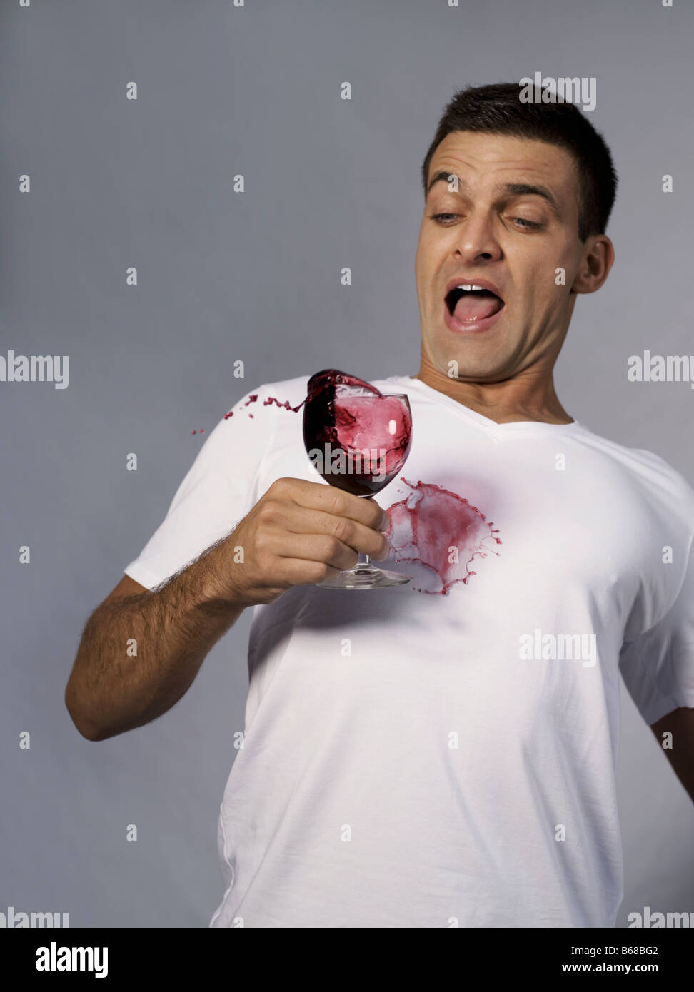 Man knocking over his glass of wine Stock Photo - Alamy