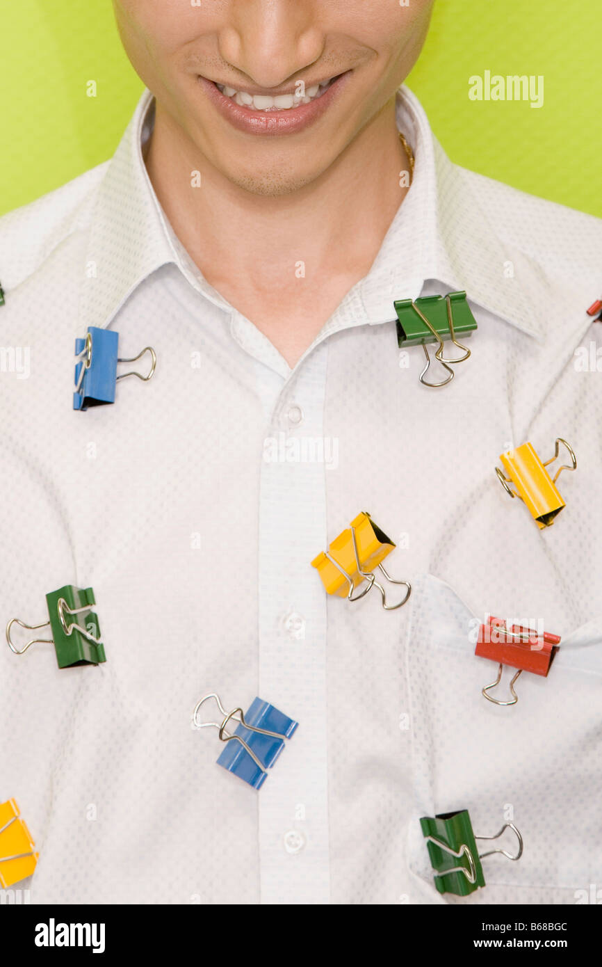 Close-up of a young man with paper clips on his shirt and smiling Stock ...