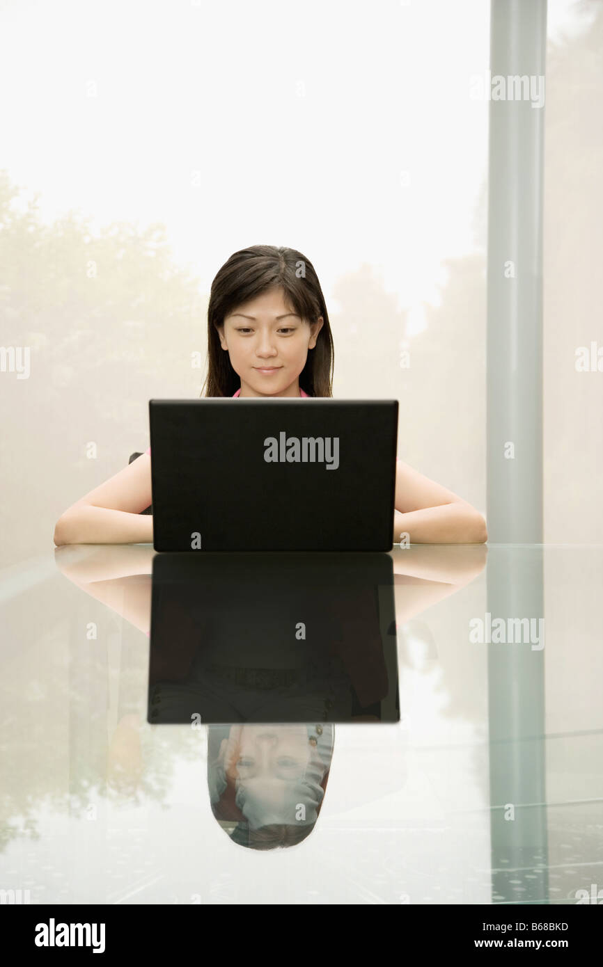 Female office worker using a laptop Stock Photo - Alamy