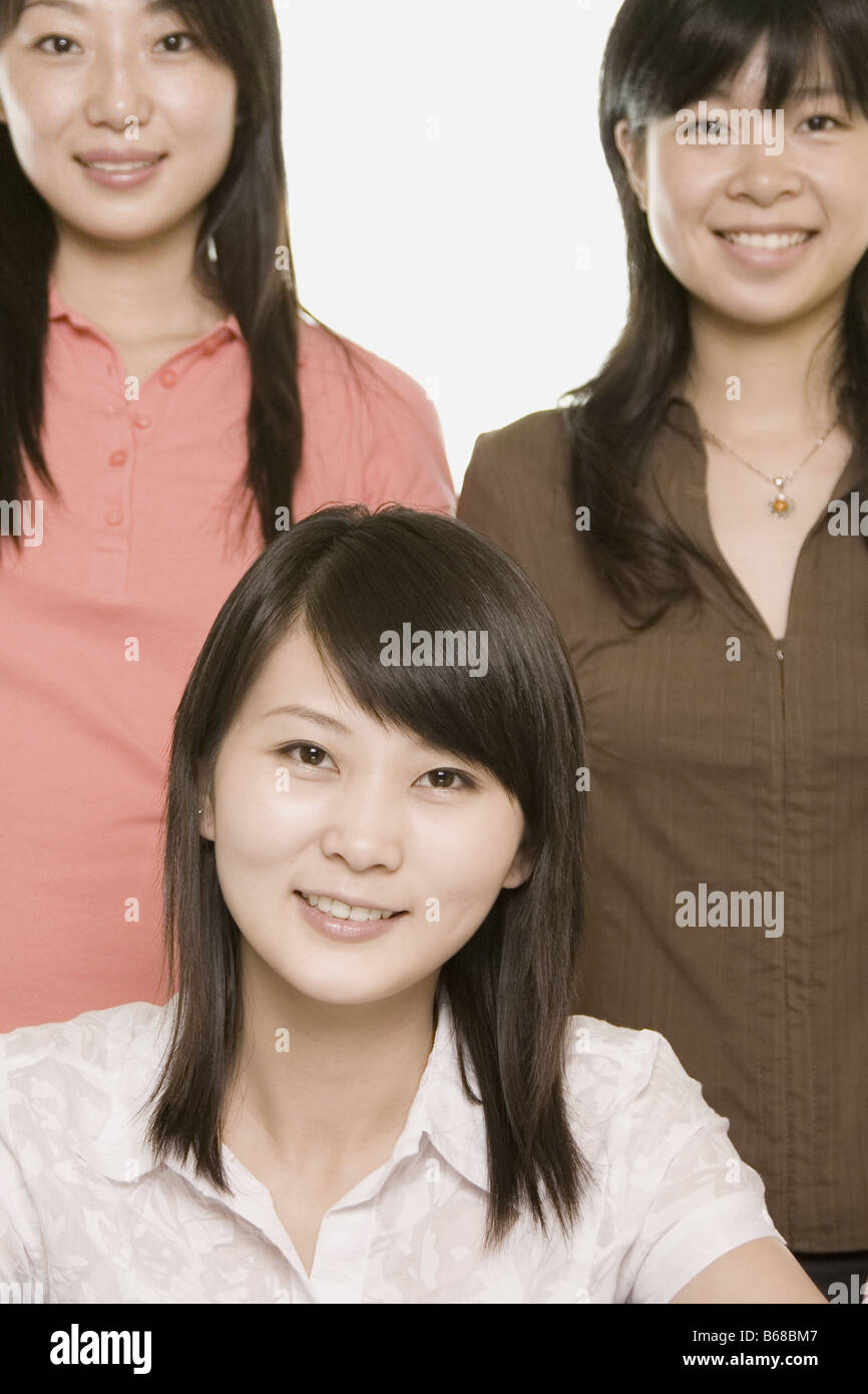 Portrait of three young women smiling Stock Photo - Alamy