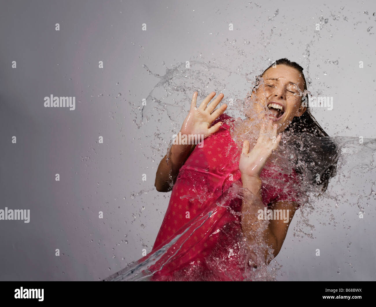 Woman splashed with water Stock Photo - Alamy