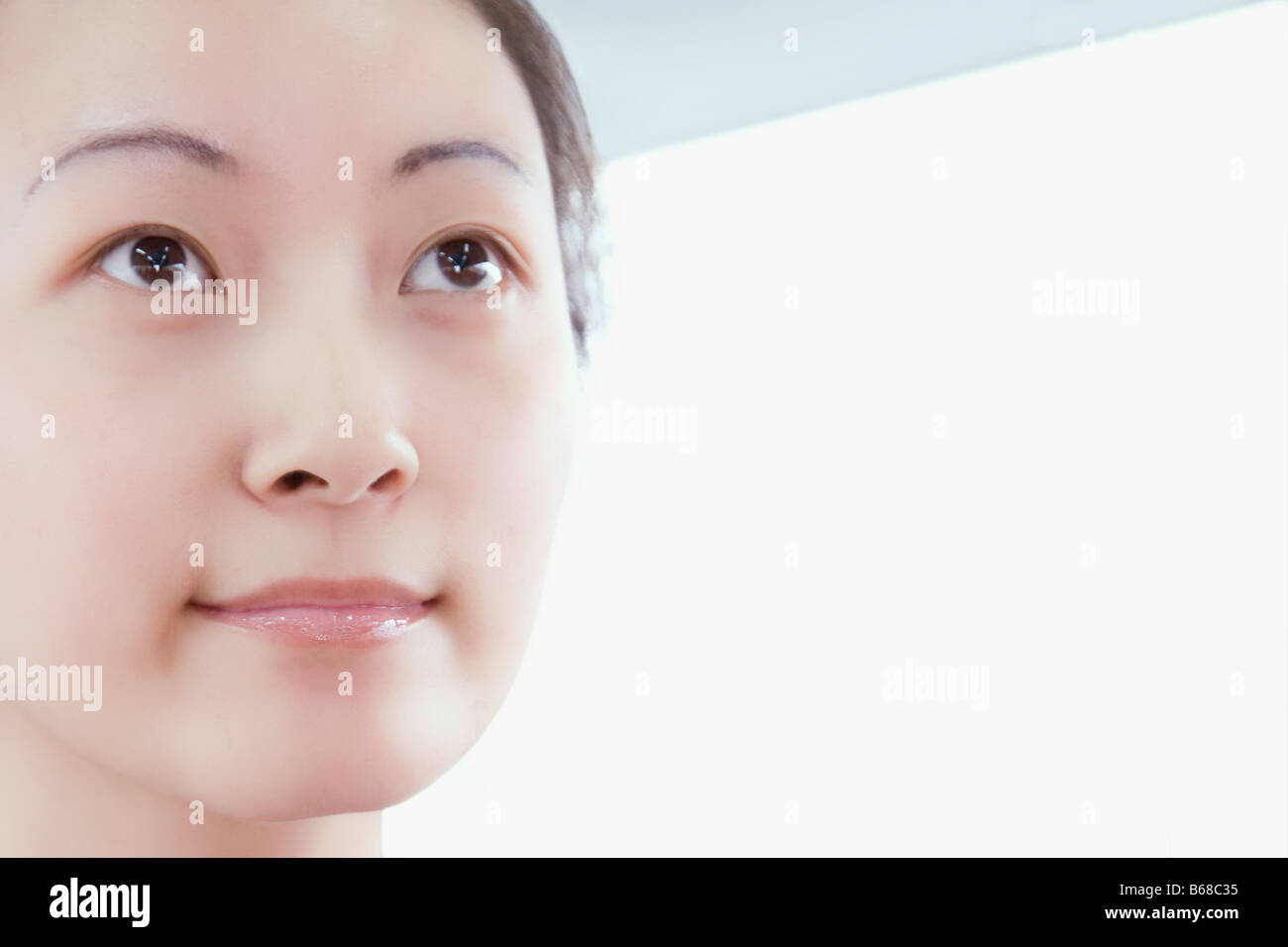 Close-up of a young woman smirking Stock Photo - Alamy