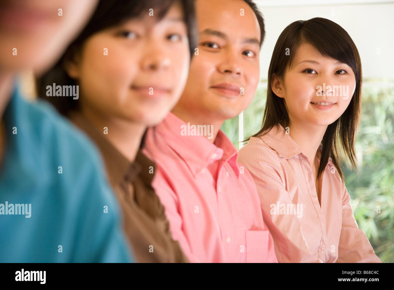 Four office workers in a row Stock Photo - Alamy