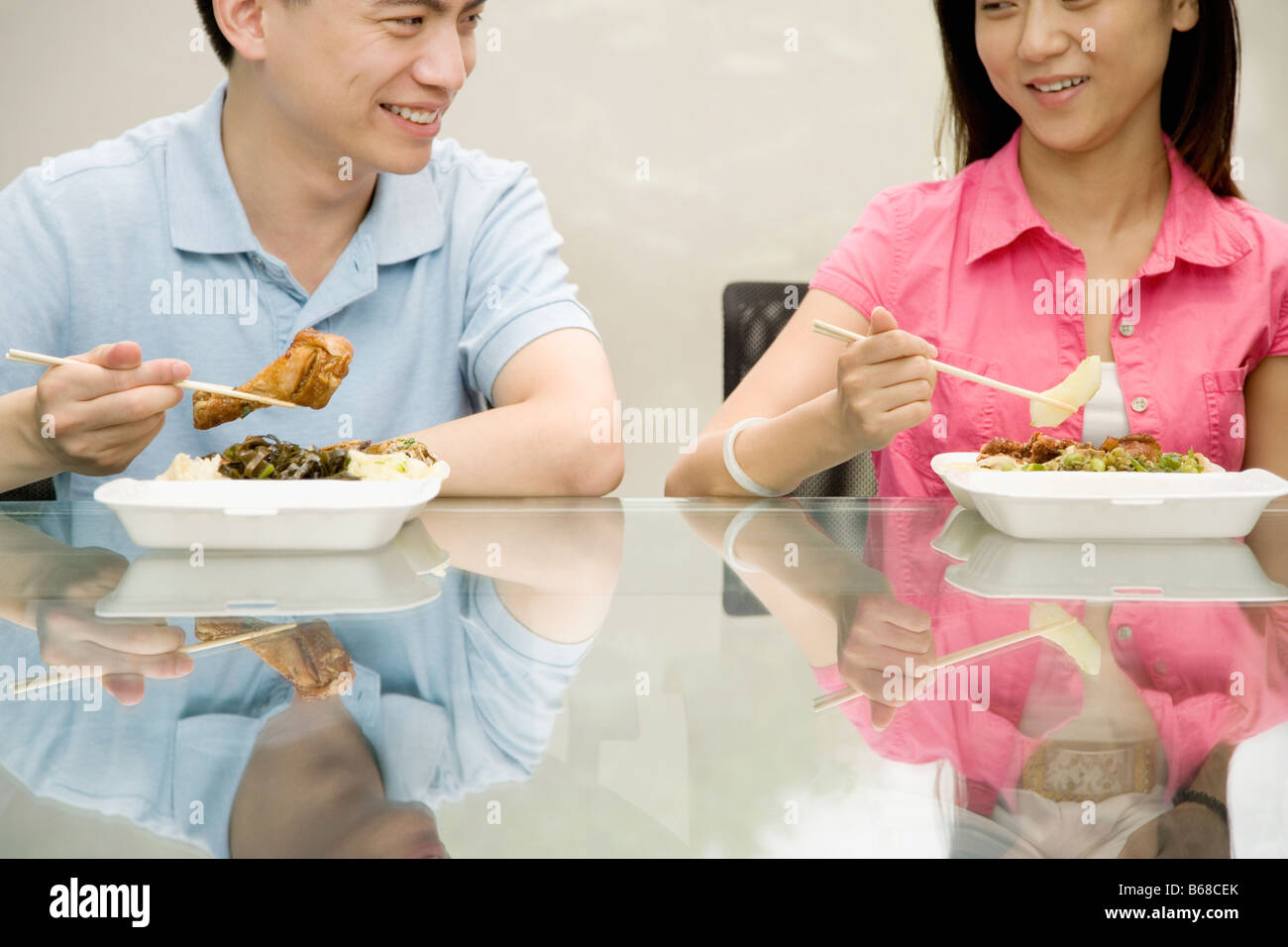 Two office workers having lunch and smiling Stock Photo - Alamy