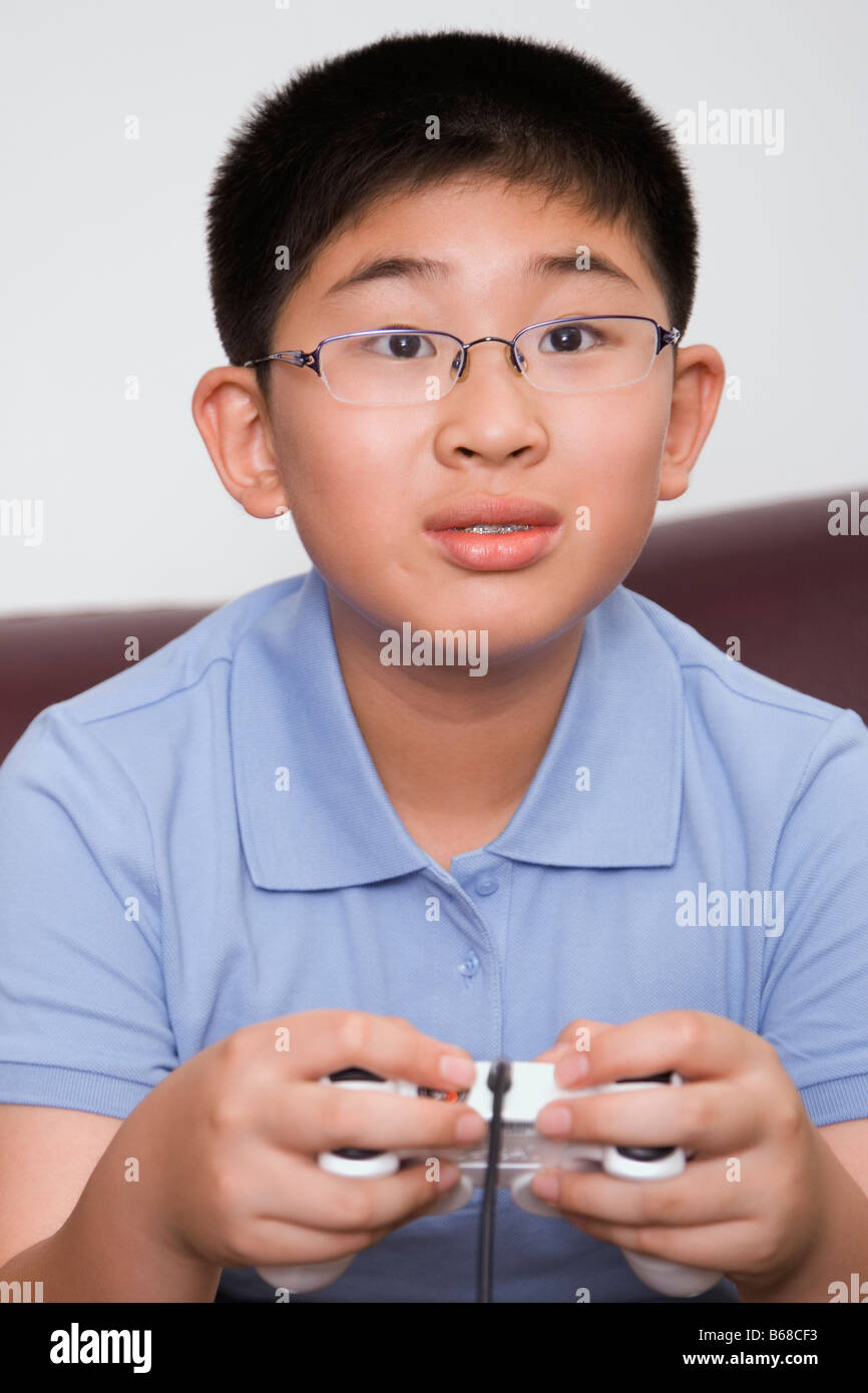 Close-up of a boy playing video game Stock Photo - Alamy