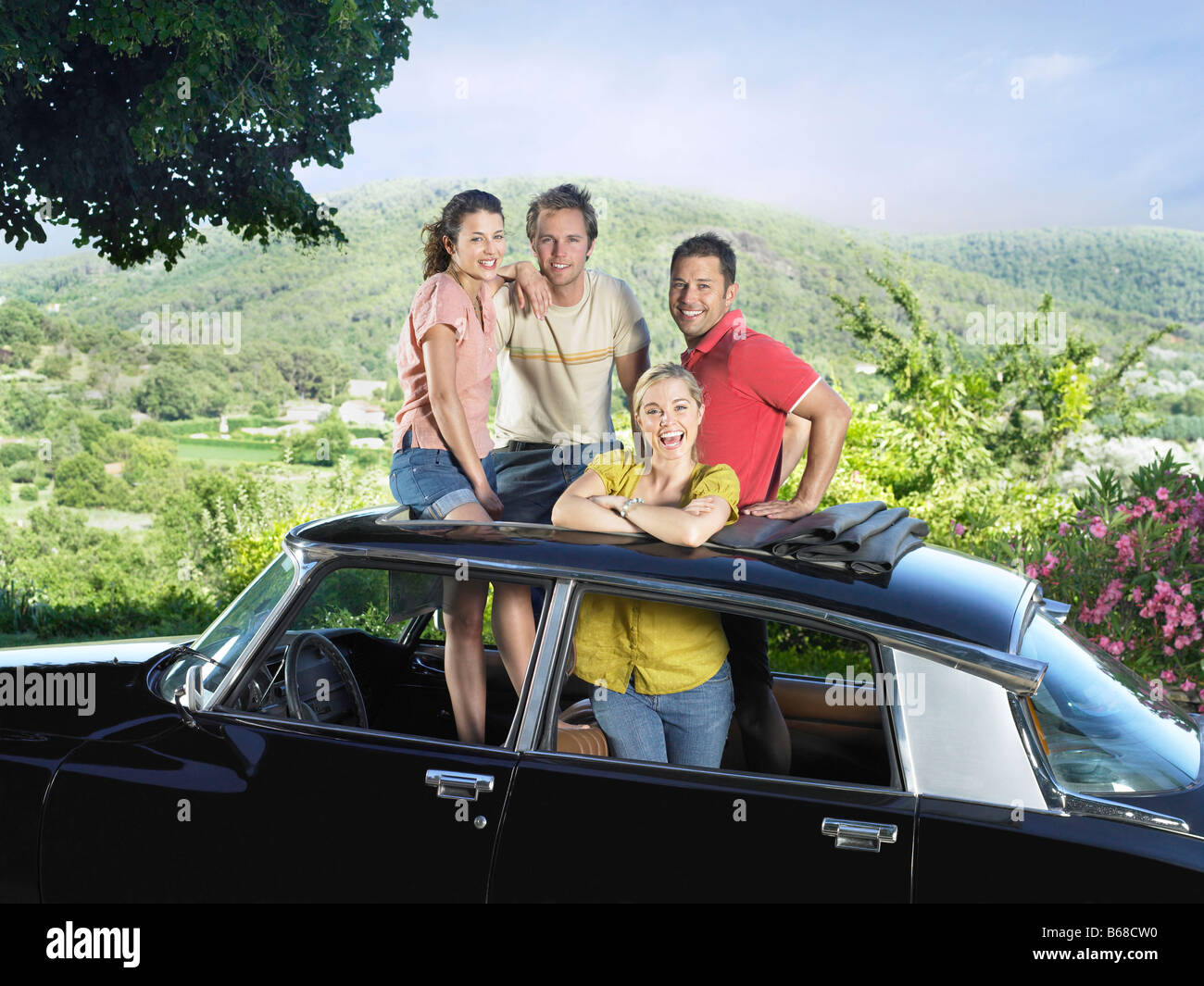 Four friends in car Stock Photo - Alamy