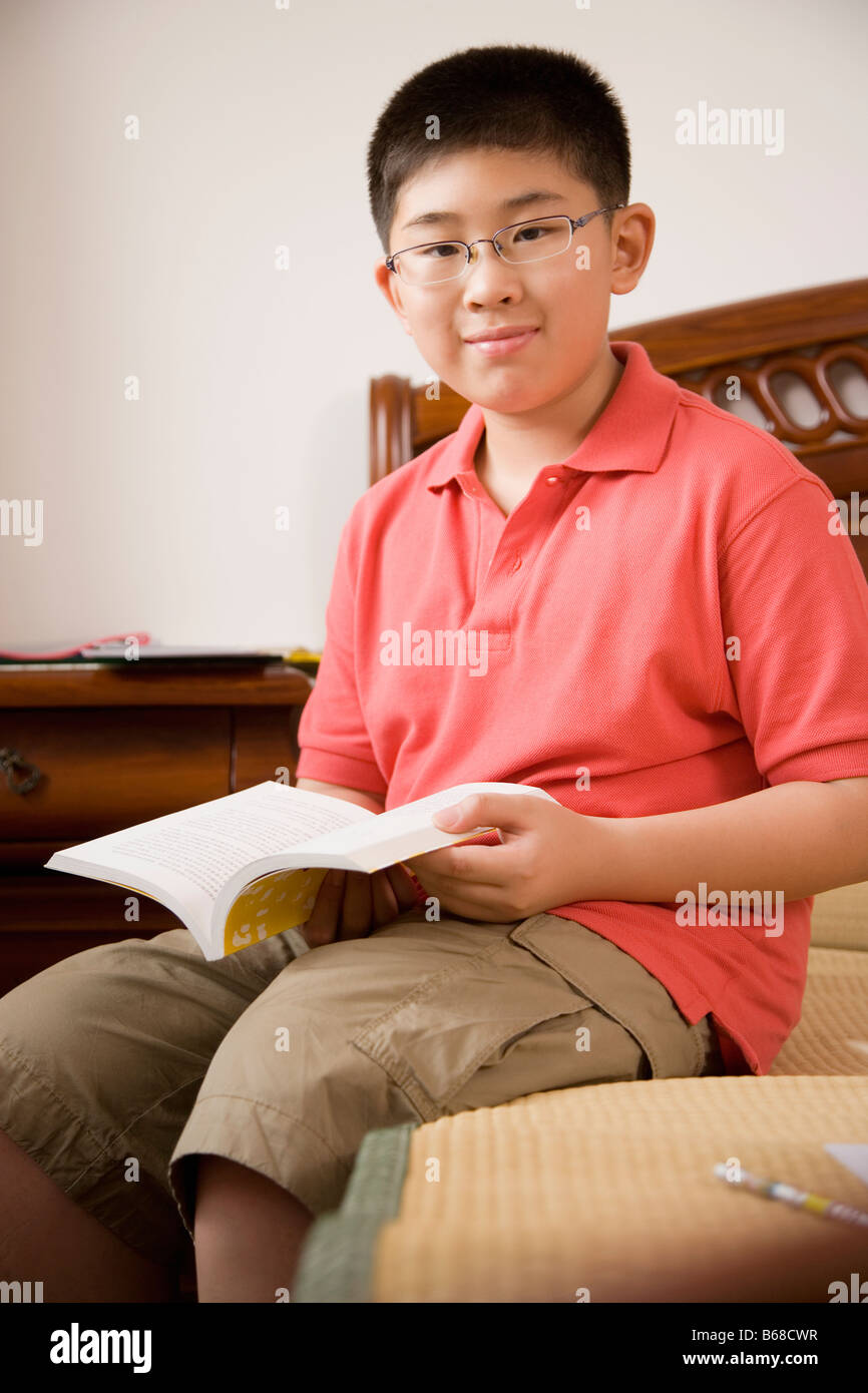 Portrait of a boy holding a book Stock Photo - Alamy