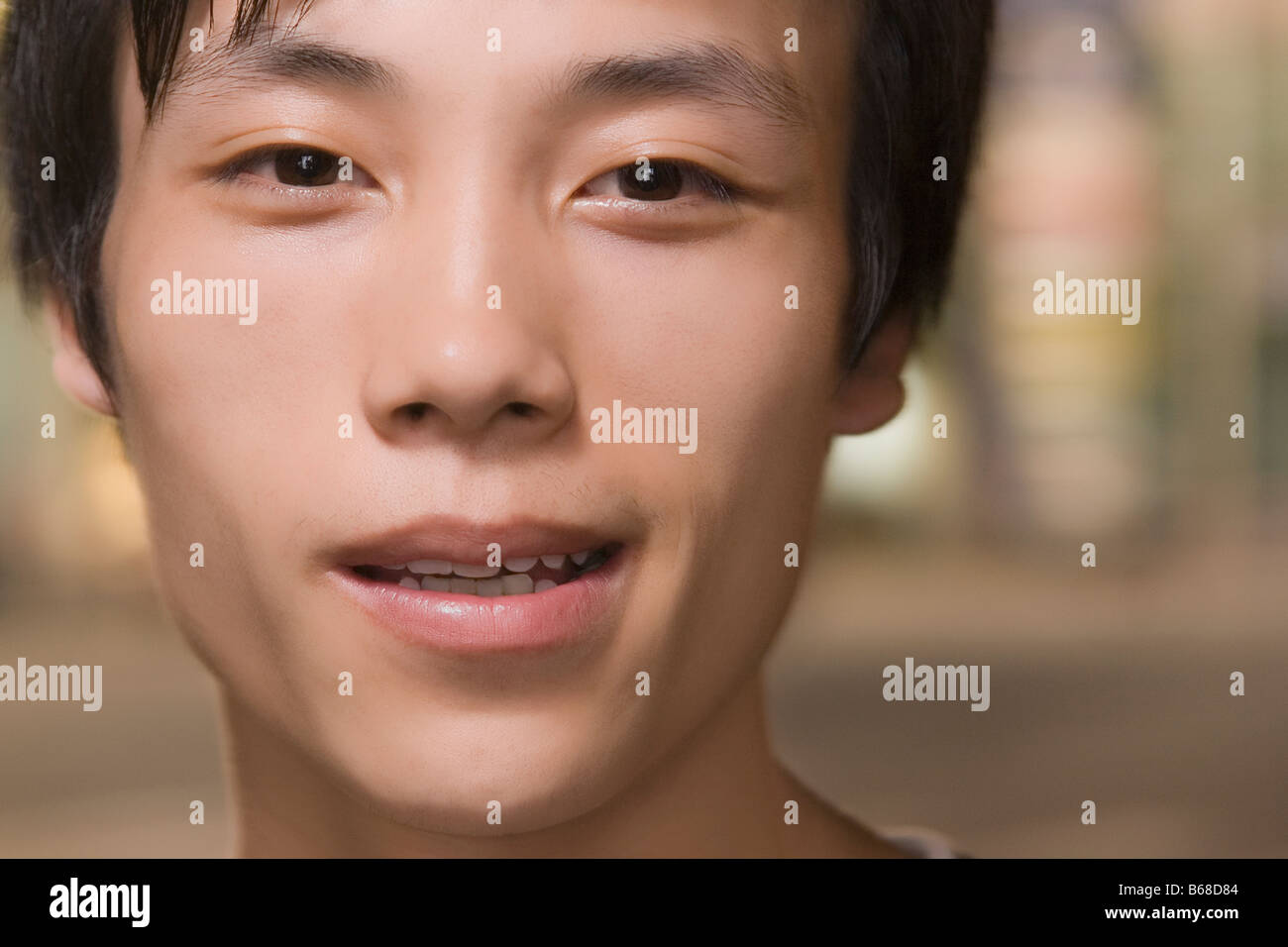 Portrait of a young man smirking Stock Photo - Alamy