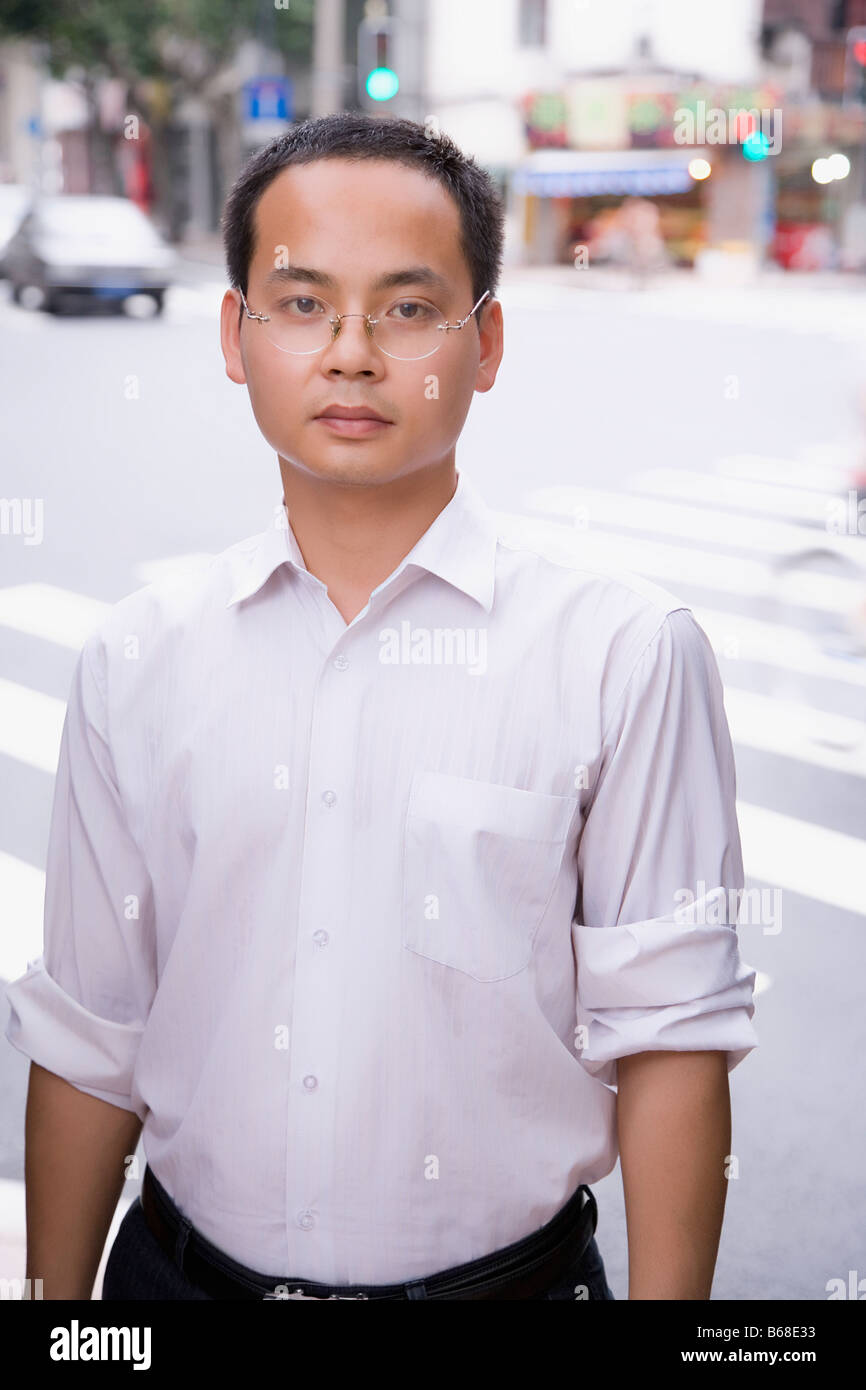 Portrait of a young man standing on a road Stock Photo - Alamy