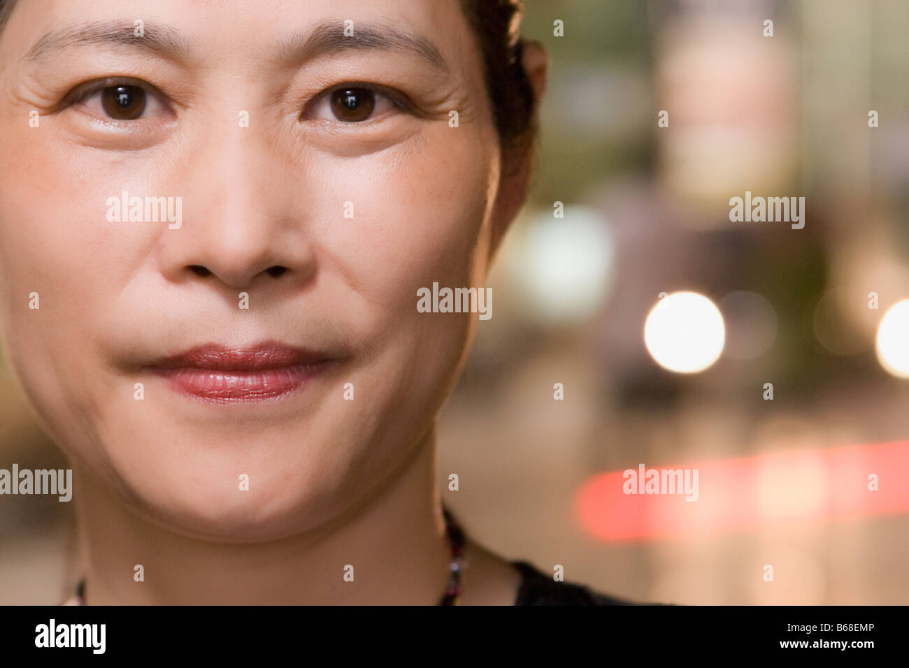 Portrait of a mature woman smirking Stock Photo - Alamy