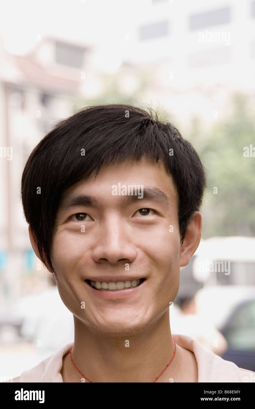 Close-up of a young man smiling Stock Photo - Alamy