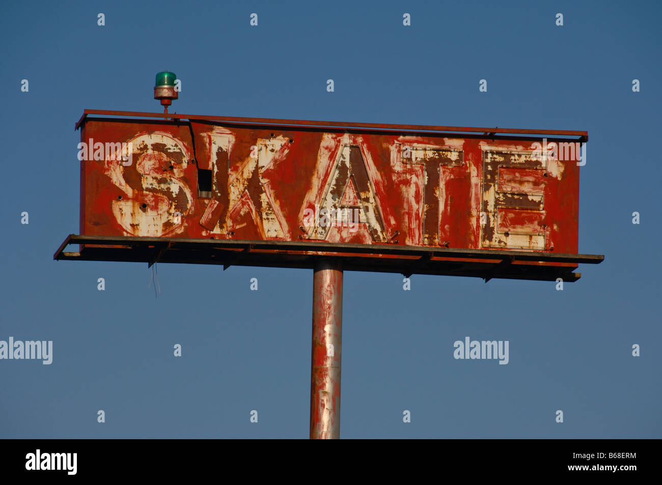 Old sign advertising a skating rink Stock Photo - Alamy
