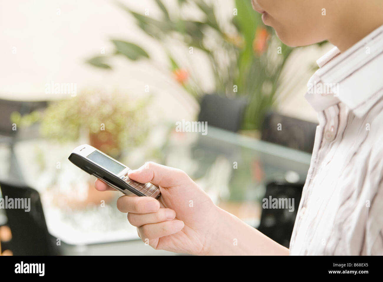 Mid section view of a male office worker operating a mobile phone Stock ...