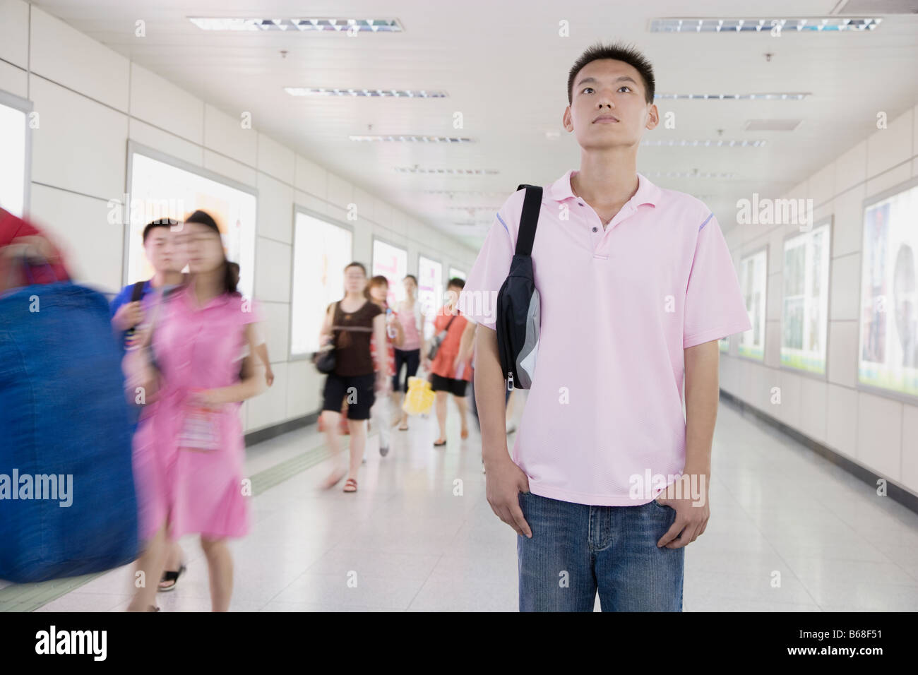 Contemplative young man walking hi-res stock photography and images - Alamy