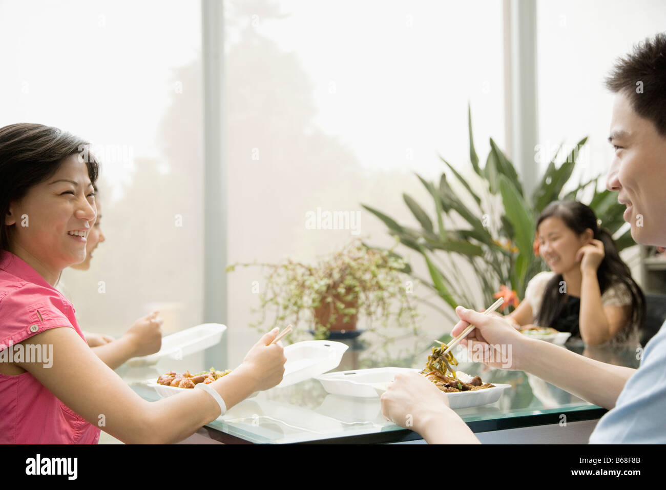 Four office workers having lunch in an office Stock Photo - Alamy