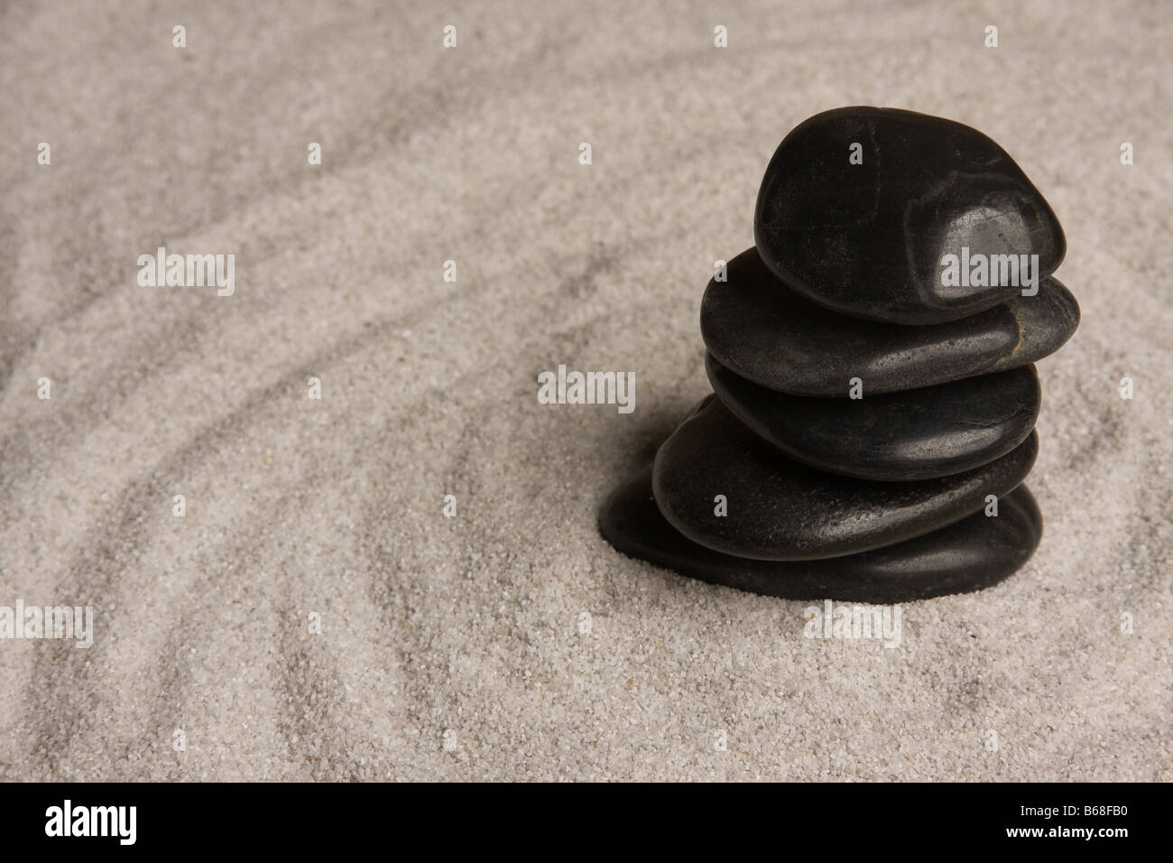 Pebbles in sand stacked hi-res stock photography and images - Alamy