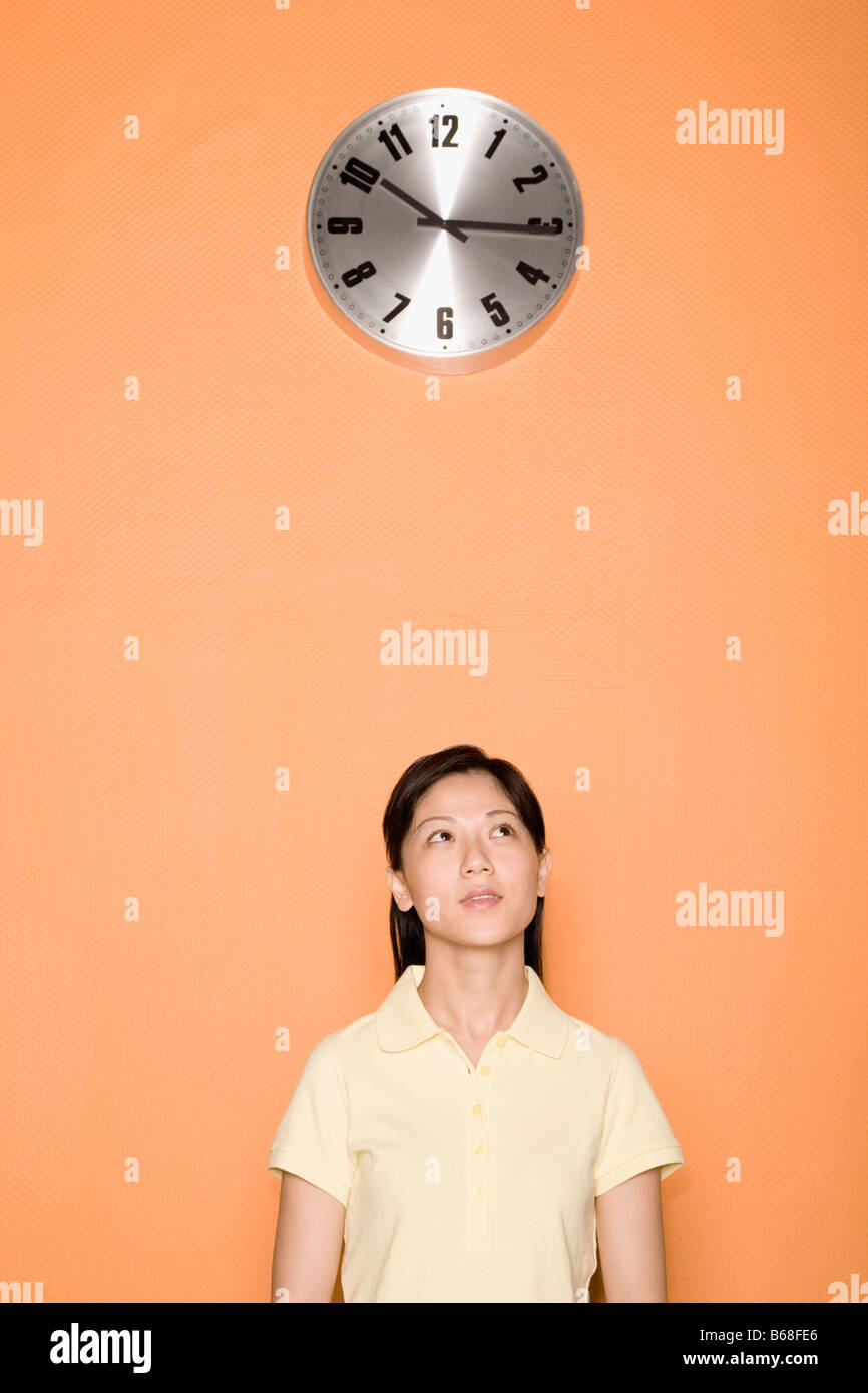 Female office worker with a clock above her head Stock Photo - Alamy