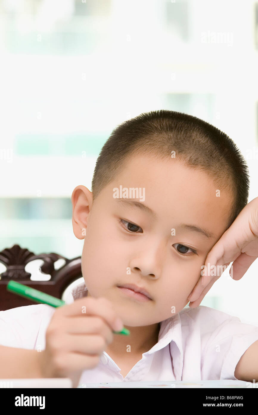 Close-up of a boy doing his homework Stock Photo - Alamy