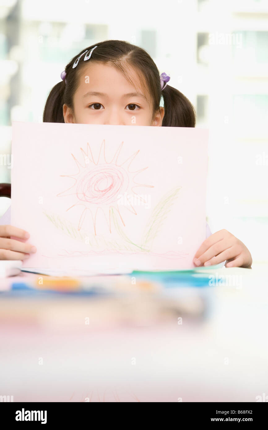 Portrait of a girl showing a drawing Stock Photo - Alamy