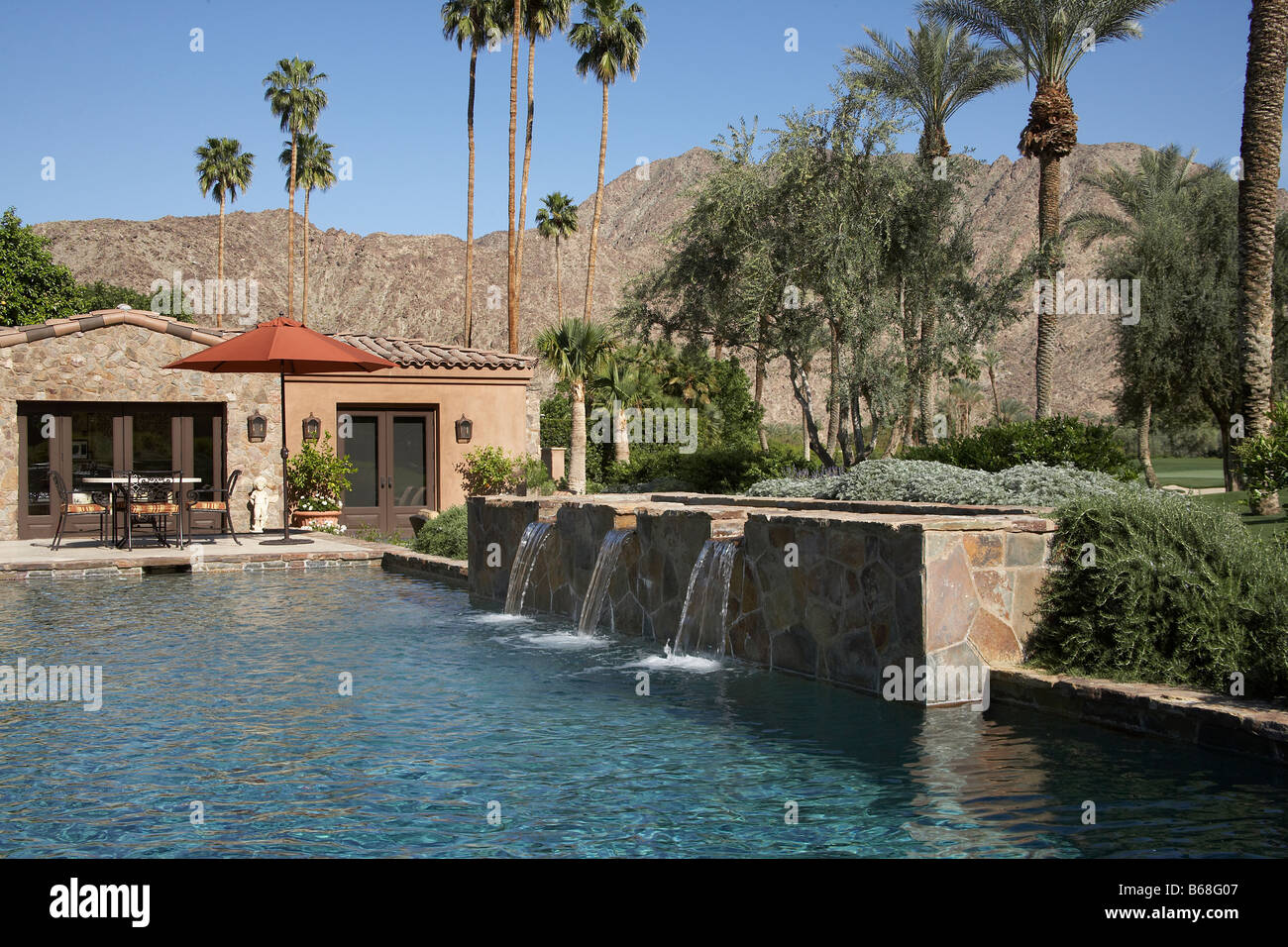 contemporary pool with pool fountain and pool house Stock Photo - Alamy