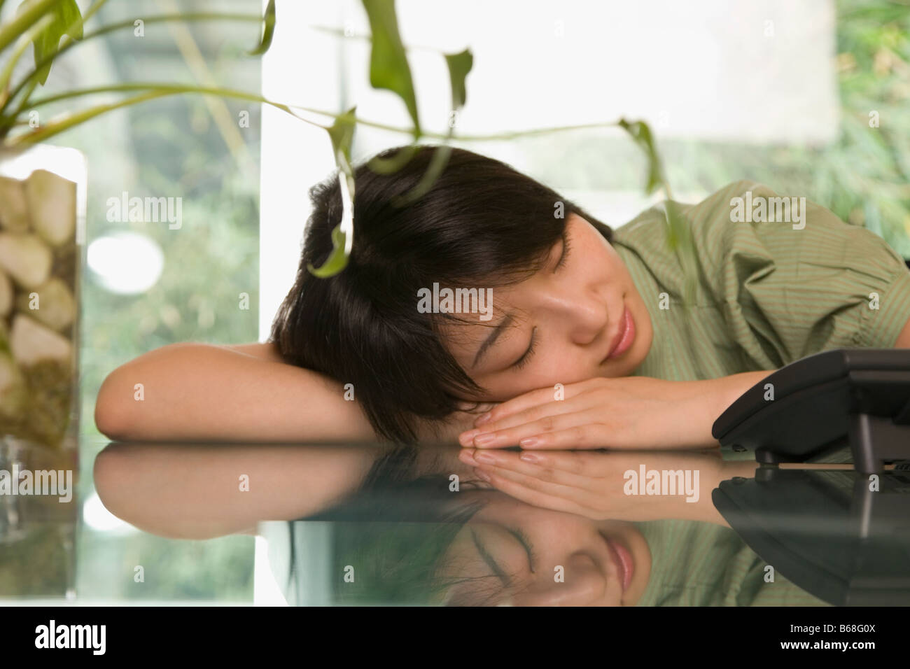 Female office worker napping at a table Stock Photo - Alamy