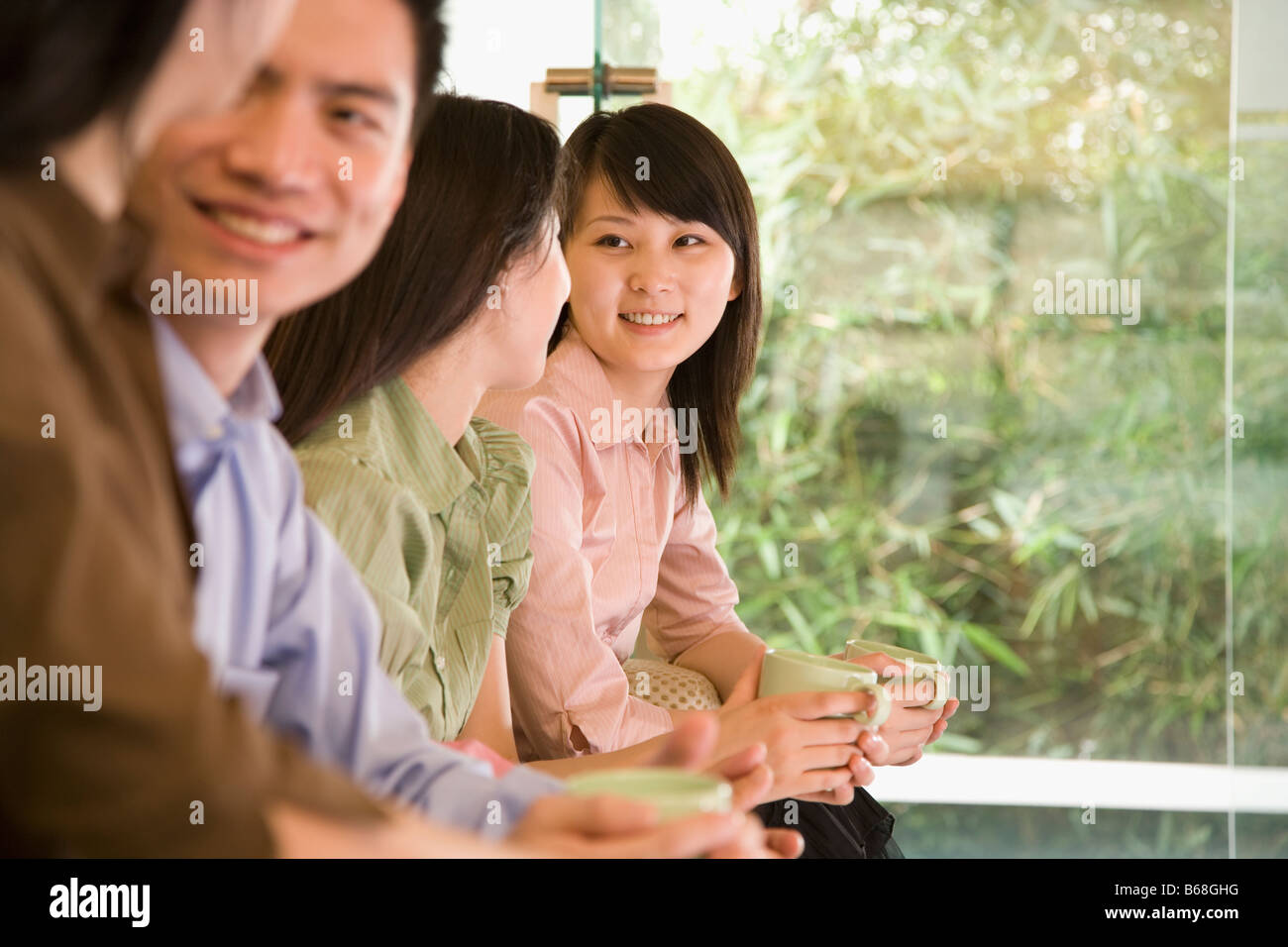 Office workers sitting side by side in an office Stock Photo - Alamy