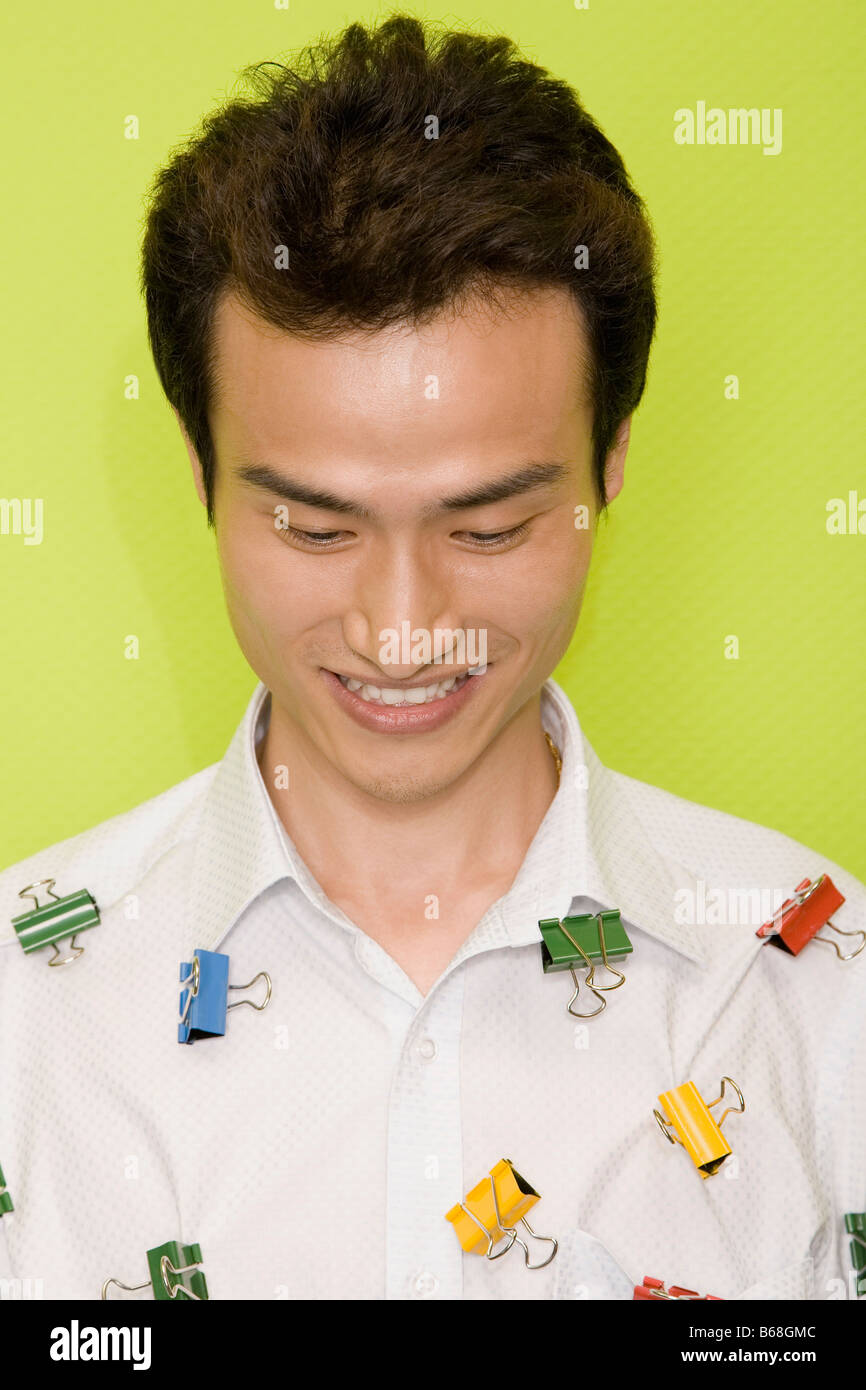Close-up of a young man with paper clips on his shirt and smiling Stock ...