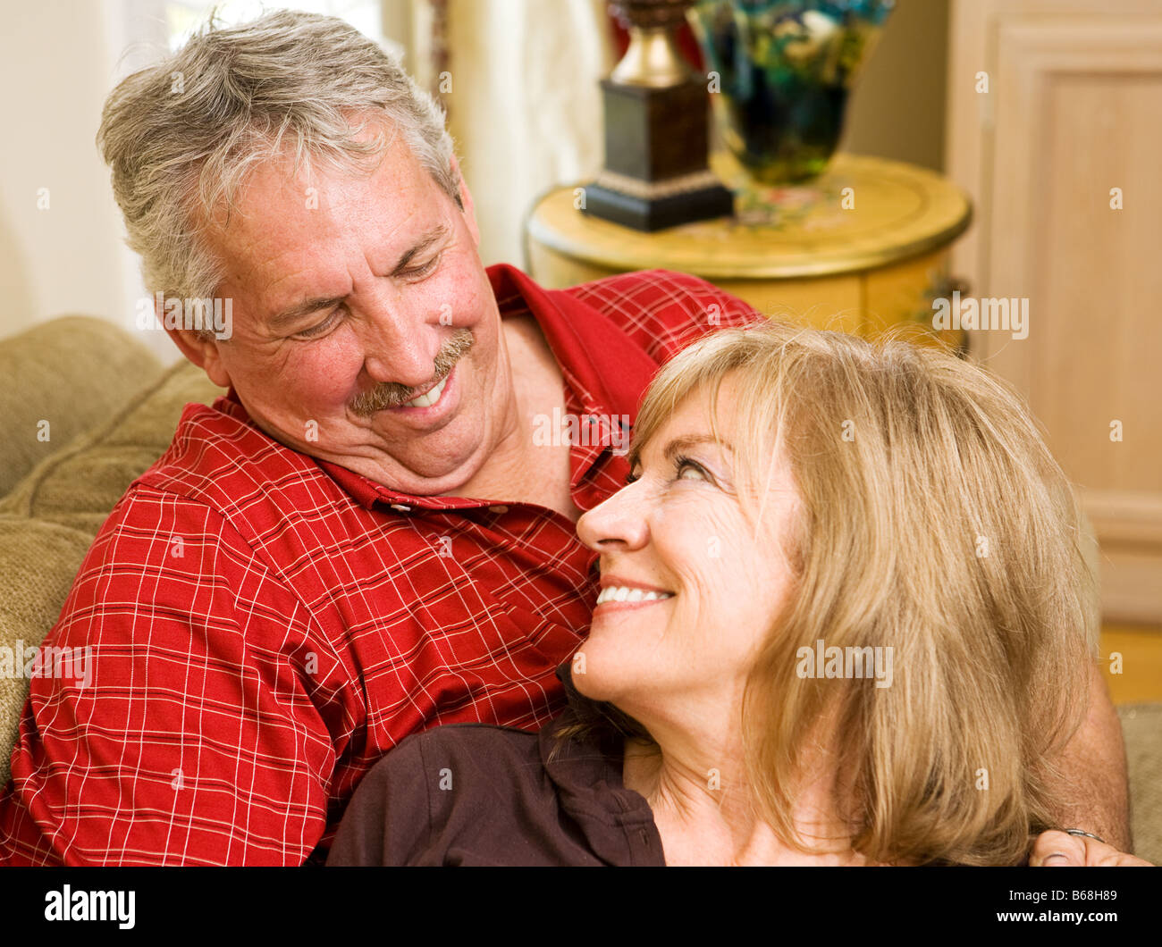 Handsome mature man gazing lovingly into the eyes of his beautiful wife ...