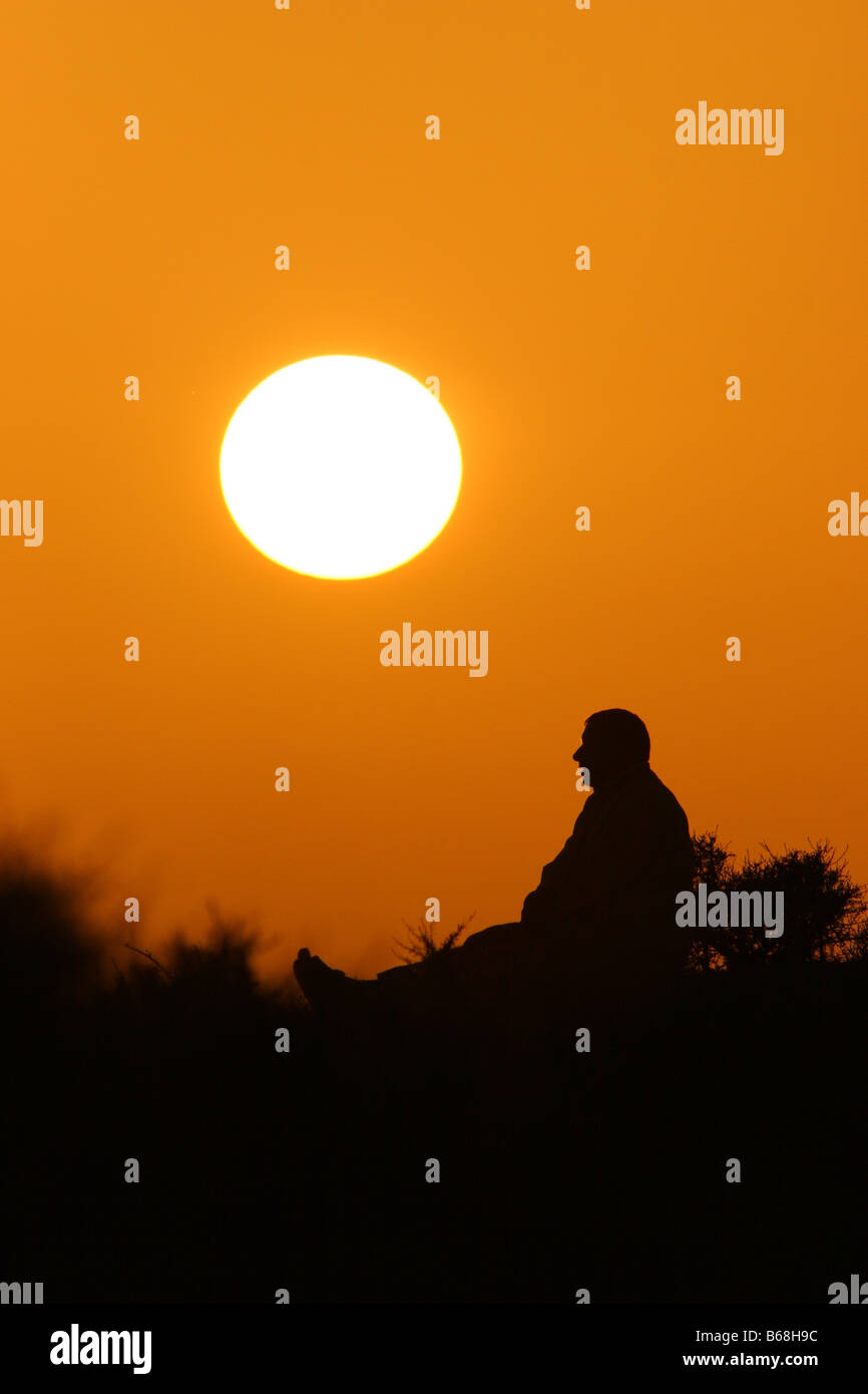 A Muslim man sitting on the hill at sunset time, praying Stock Photo ...