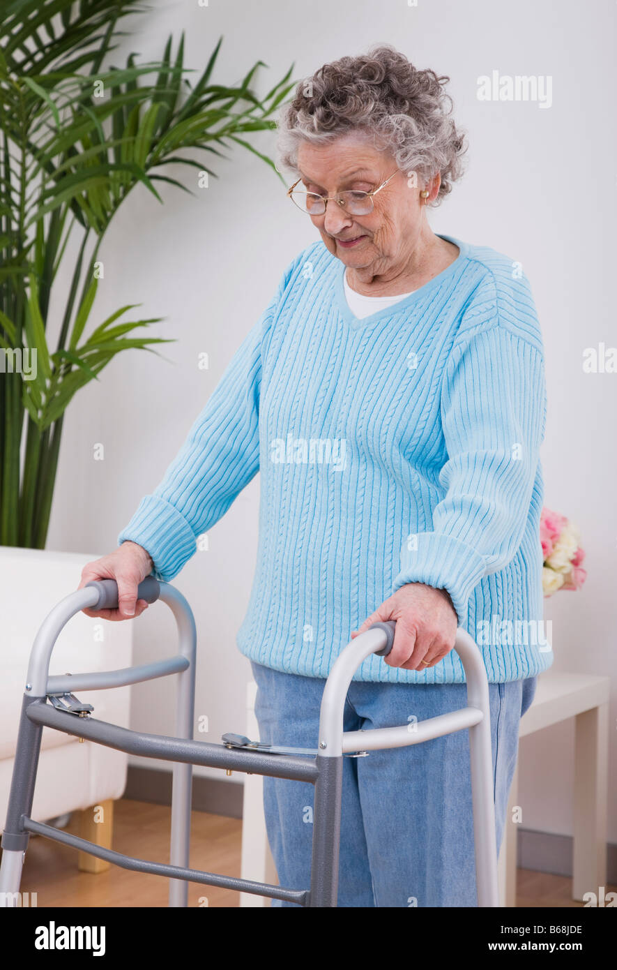 Senior woman with walker Stock Photo - Alamy