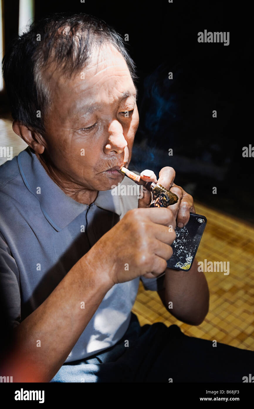 China man lighting a cigarette hi-res stock photography and images - Alamy