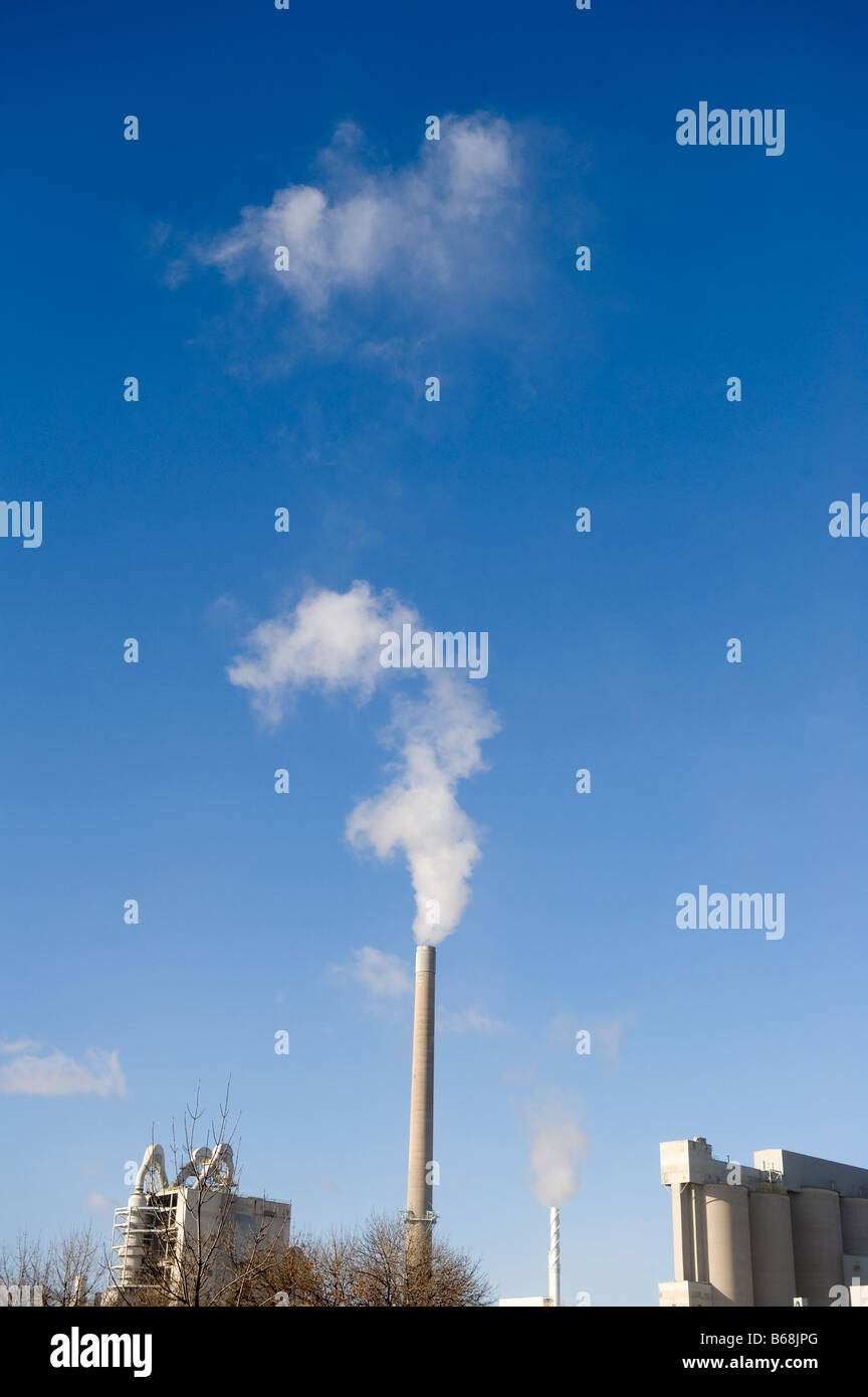 Cement factory with smoking chimneys and building Stock Photo - Alamy