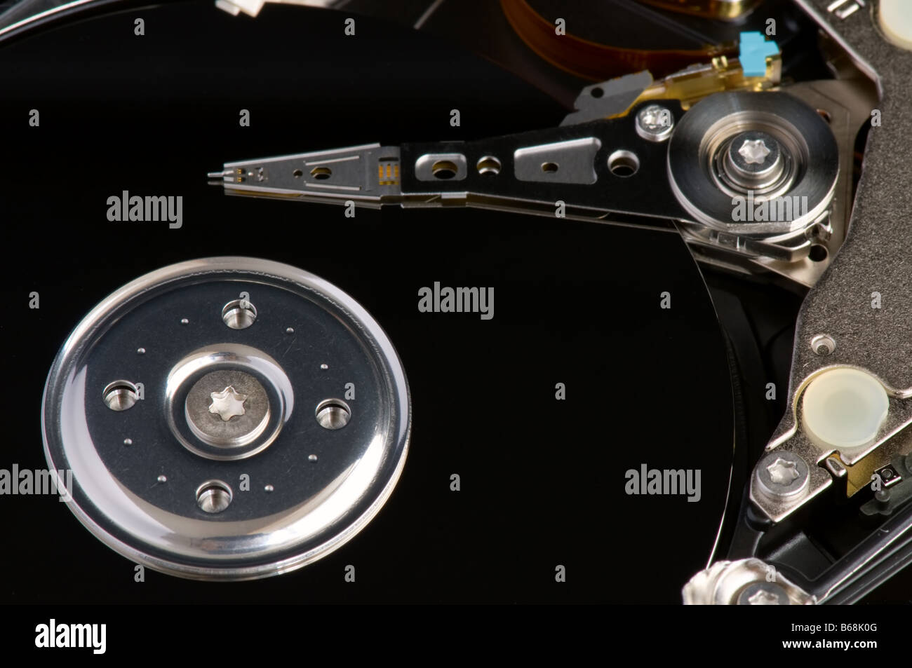 Opened hard disk showing the disk surface and drive head in dark Stock ...