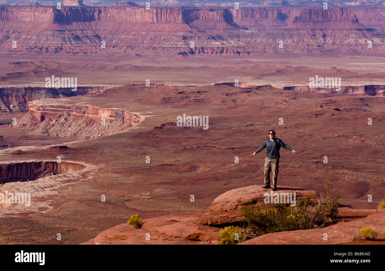 A male figure standing at the edge of a cliff overlooking the Colorado ...