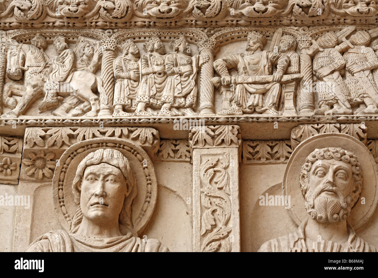 Romanesque stone bas relief on portal of the Saint Trophimus cathedral ...