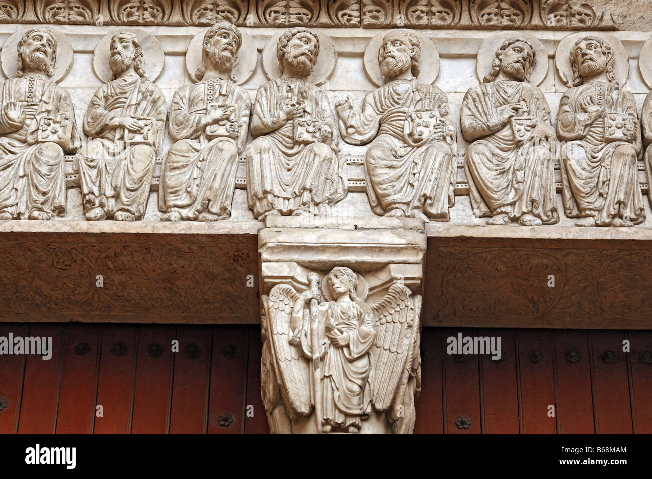 Romanesque stone bas relief on portal of the Saint Trophimus cathedral ...