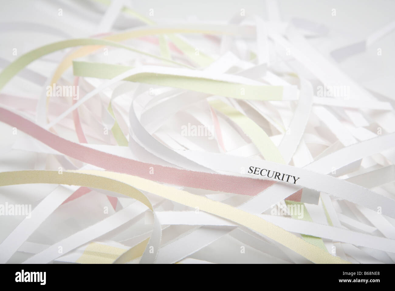 Shredded paper One shred showing the word security Stock Photo - Alamy