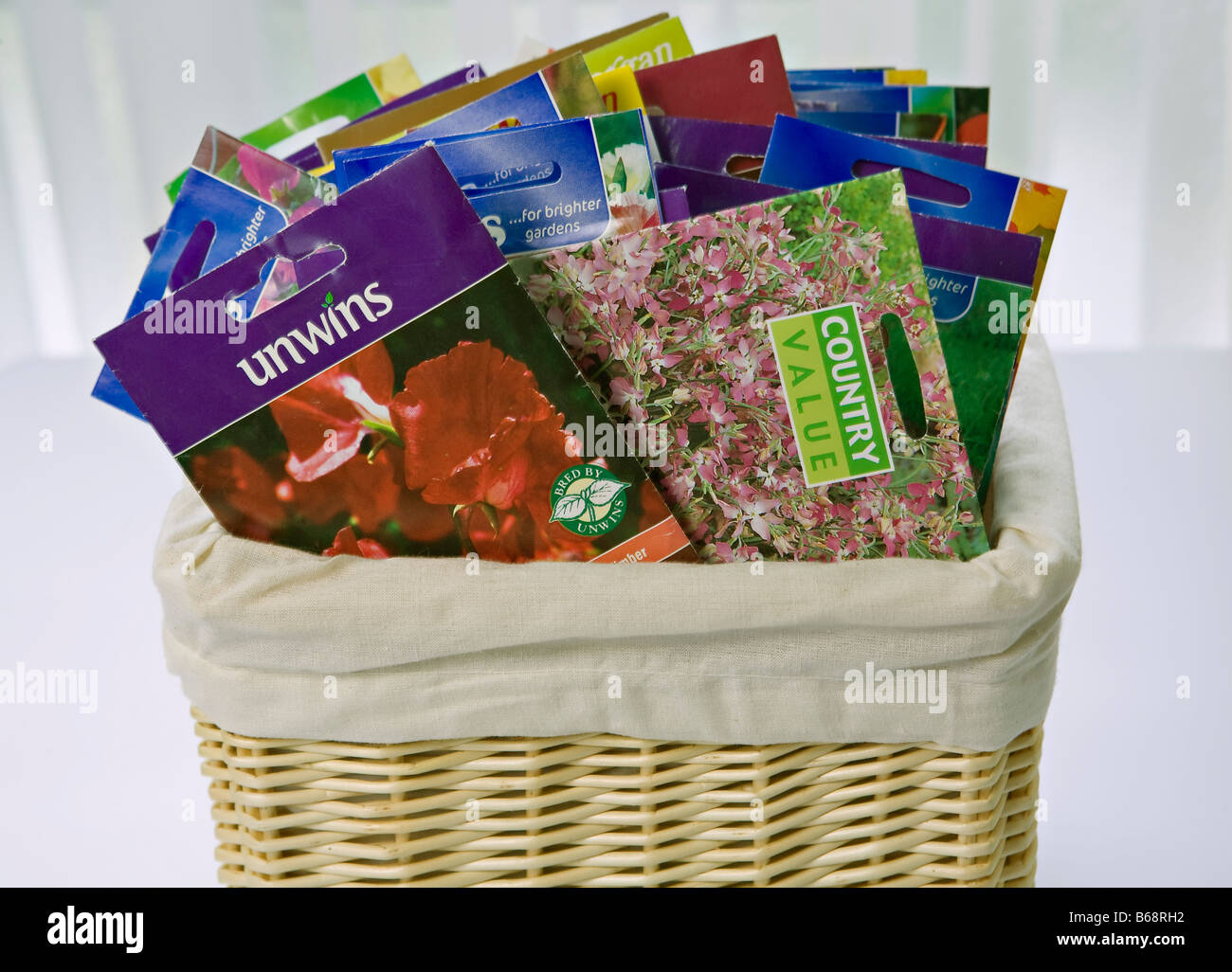 Several flower seed packets in a basket ready to be opened and sown ...