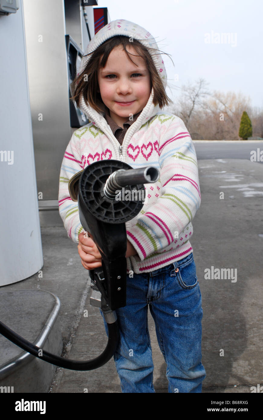 Kid pumping gas Stock Photo - Alamy