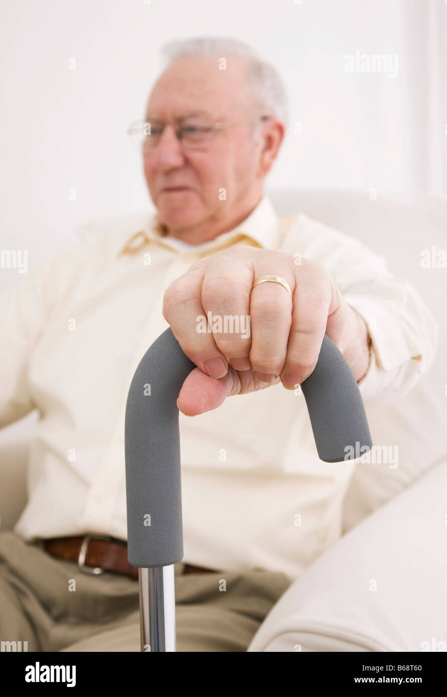 Senior man with hand on walking cane, close-up Stock Photo - Alamy