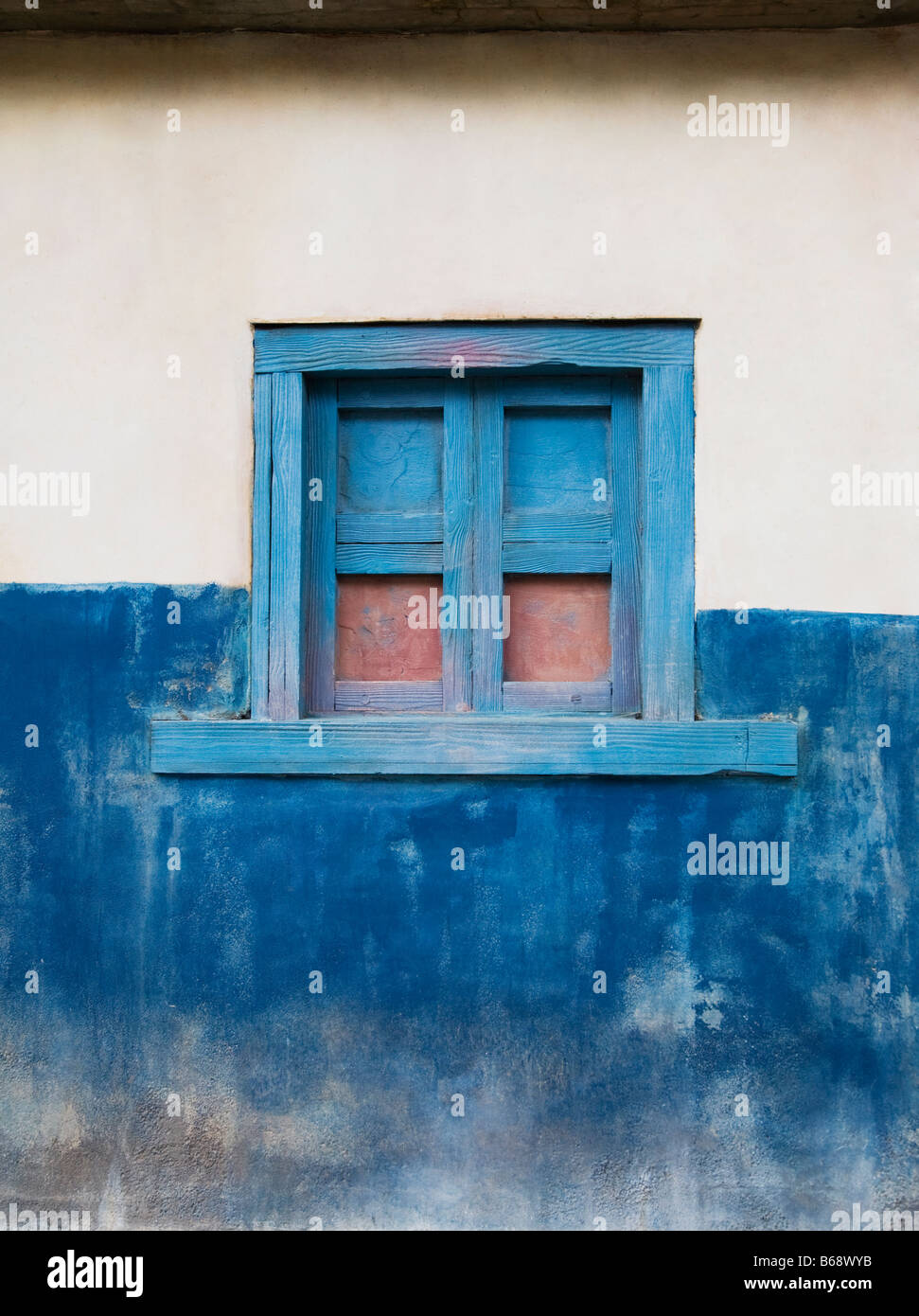 Blue window in painted wall Stock Photo - Alamy