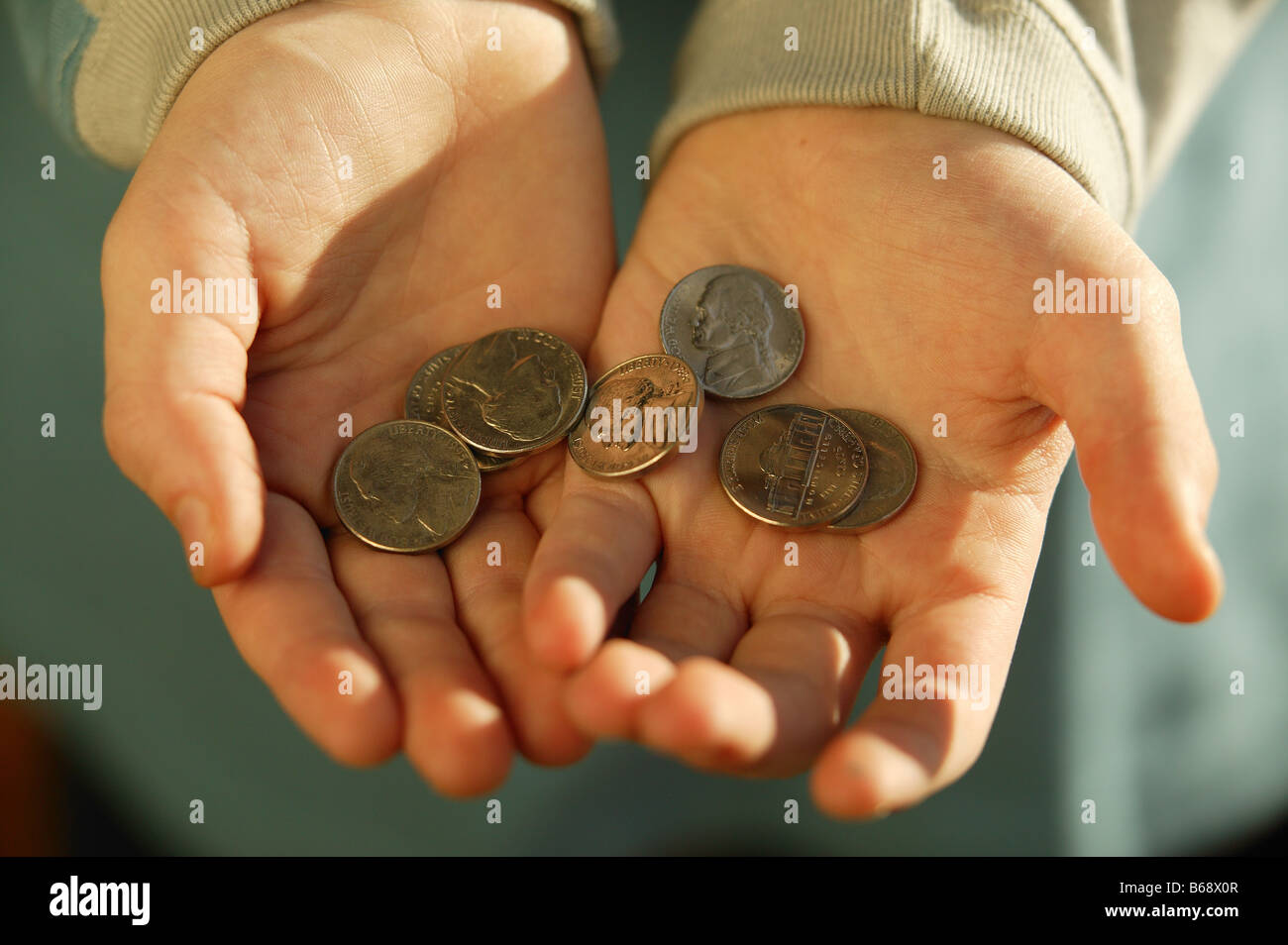 Hand filled with Quarters Stock Photo - Alamy
