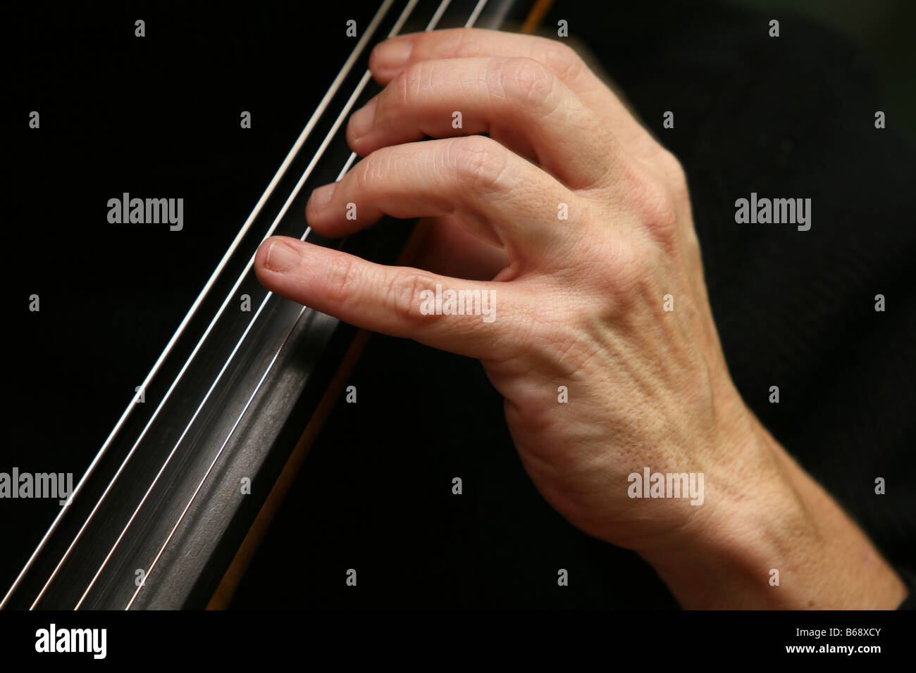 Cellist playing notes Stock Photo - Alamy