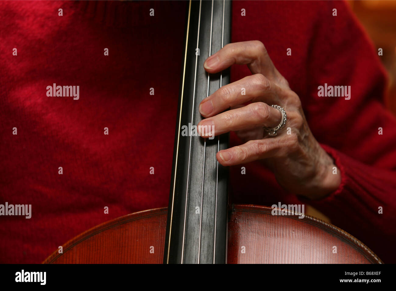 Elderly woman cellist playing notes Stock Photo - Alamy
