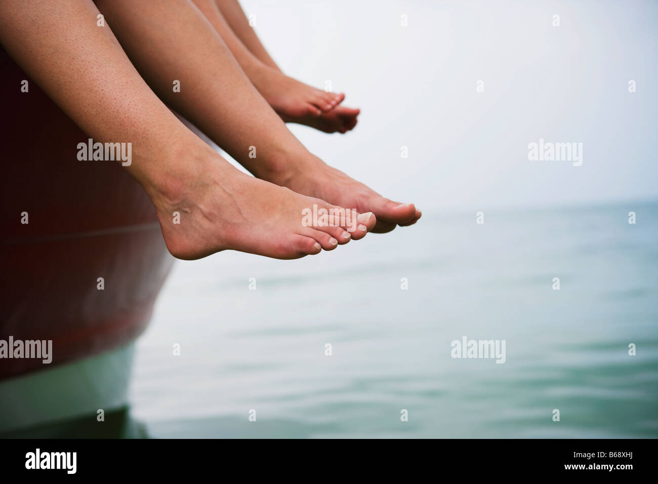 People's feet over ocean Stock Photo - Alamy