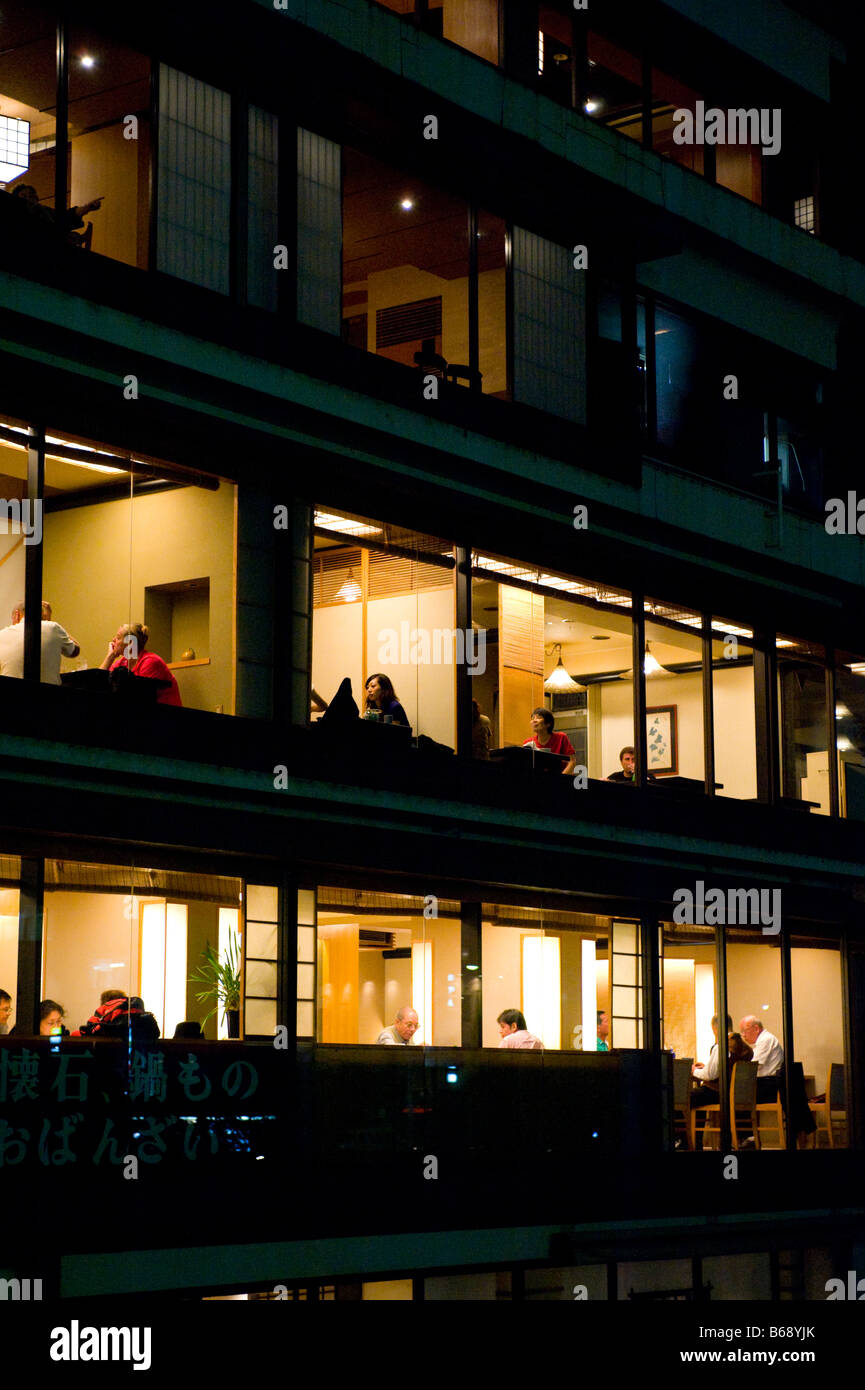 Diners seen through the windows of a restaurant in Kyoto, Japan Stock ...
