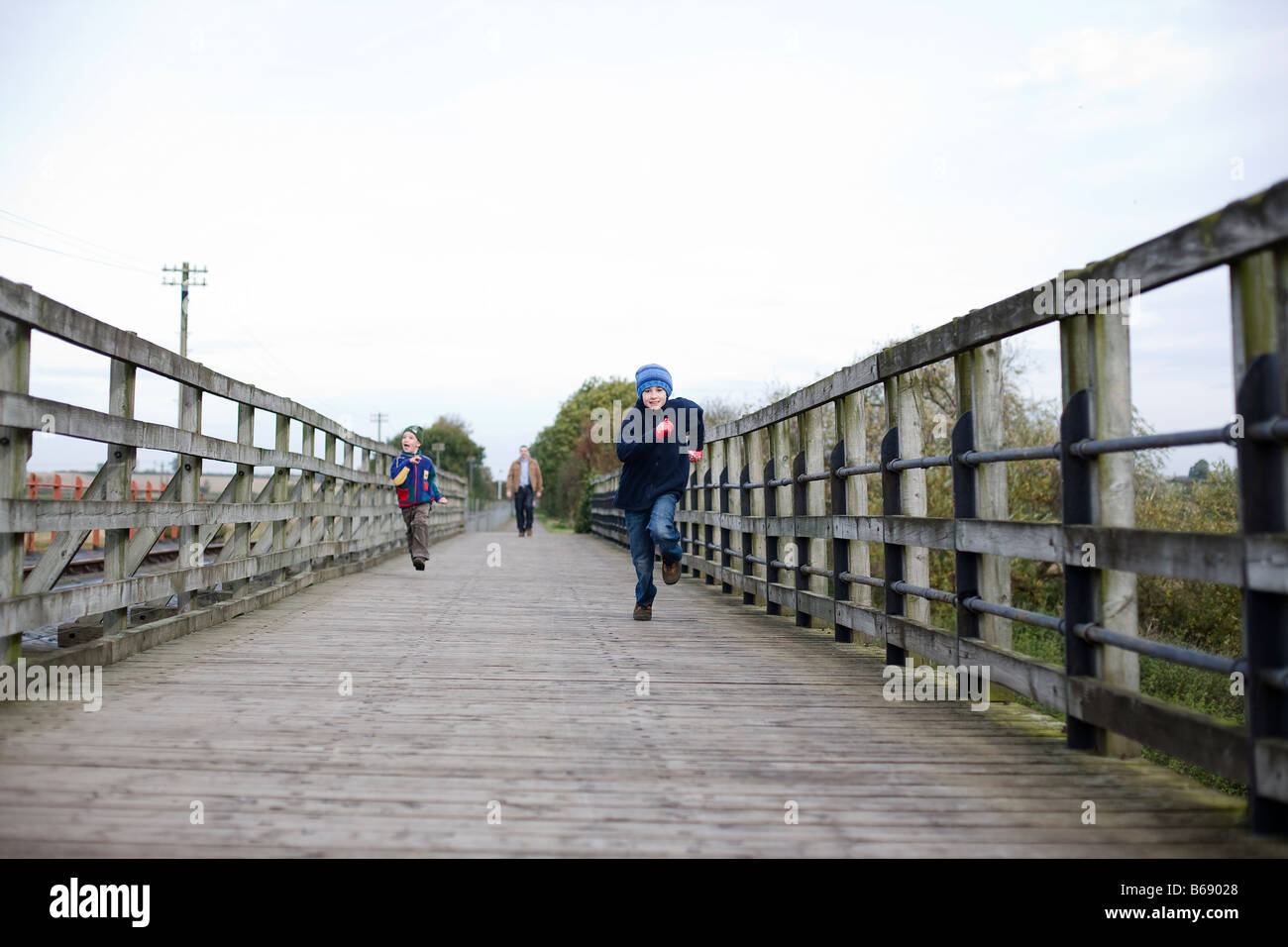 Two boys race over a bridge in Northamptonshire MODEL RELEASE AVAILABLE ...